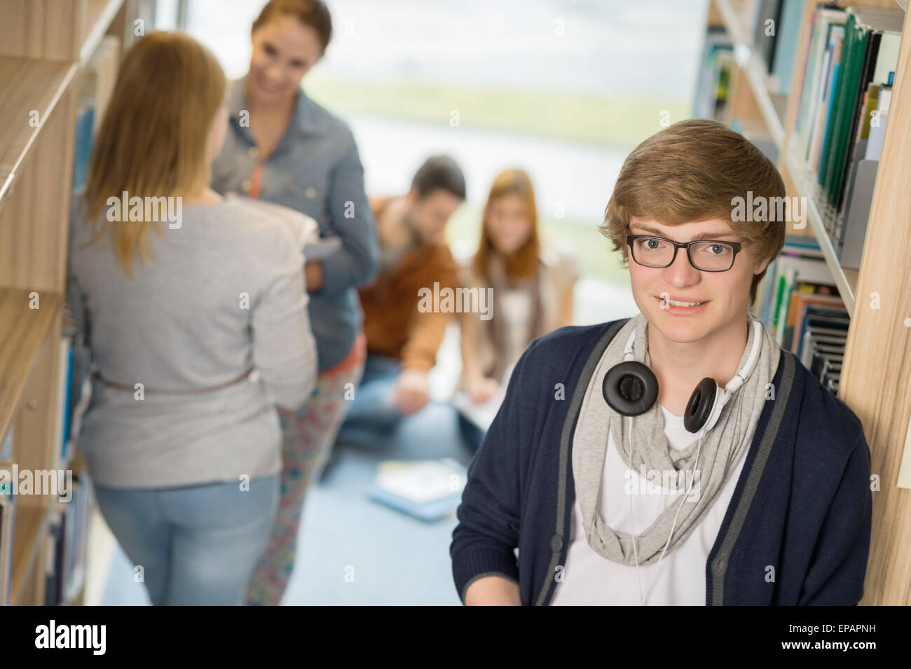 Student with headphones in library Stock Photo - Alamy