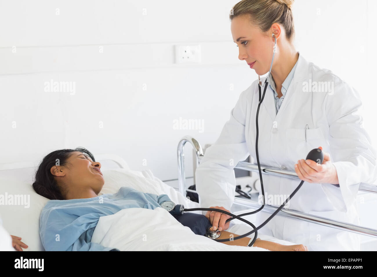 Doctor checking patients blood pressure Stock Photo - Alamy