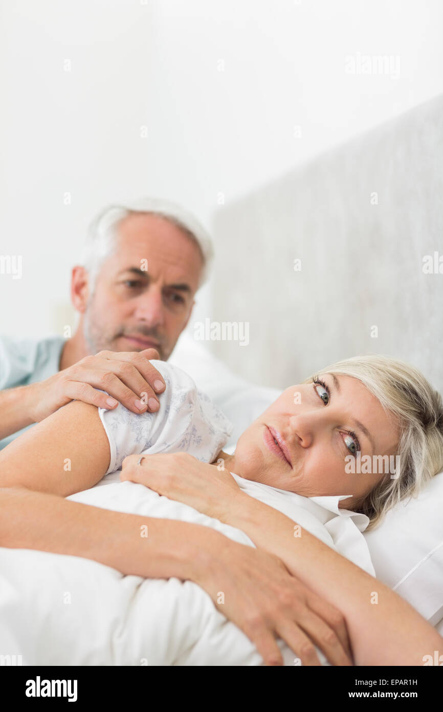 Woman consoling man bed hi-res stock photography and images - Alamy