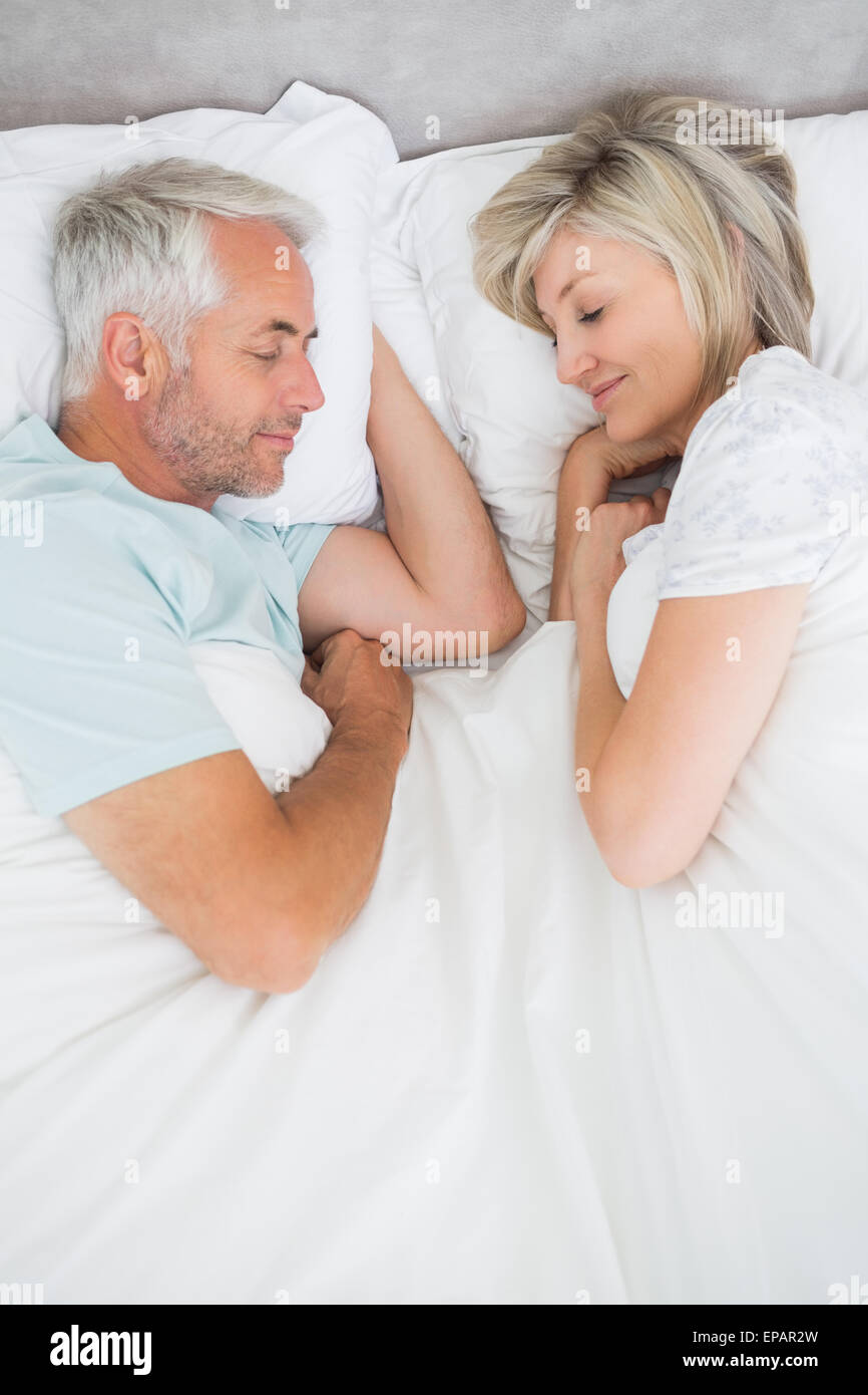 Mature couple lying in bed Stock Photo - Alamy