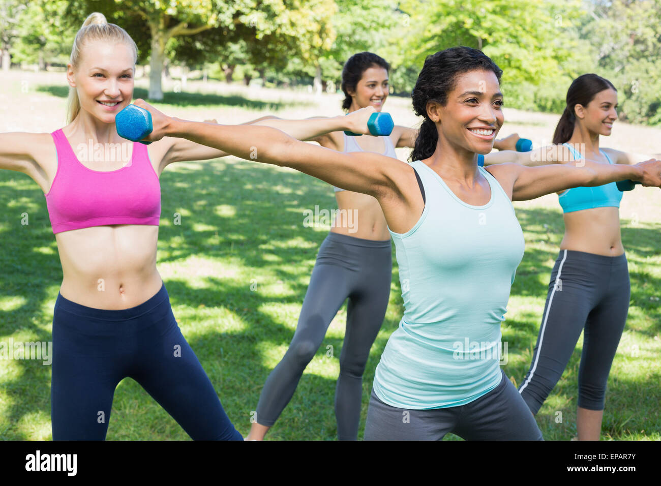 Sporty women lifting hands weights Stock Photo - Alamy