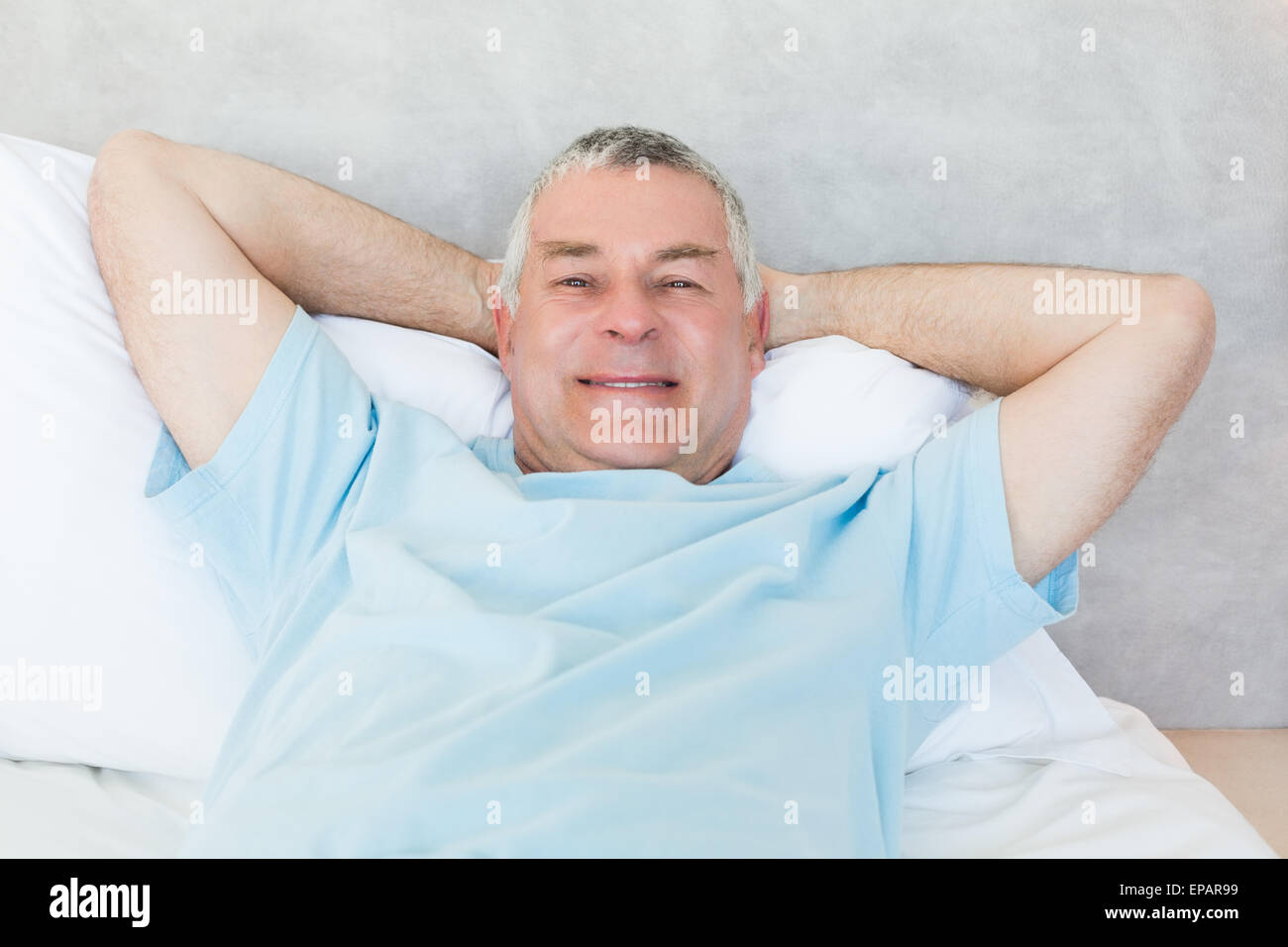 Senior man lying in bed Stock Photo - Alamy