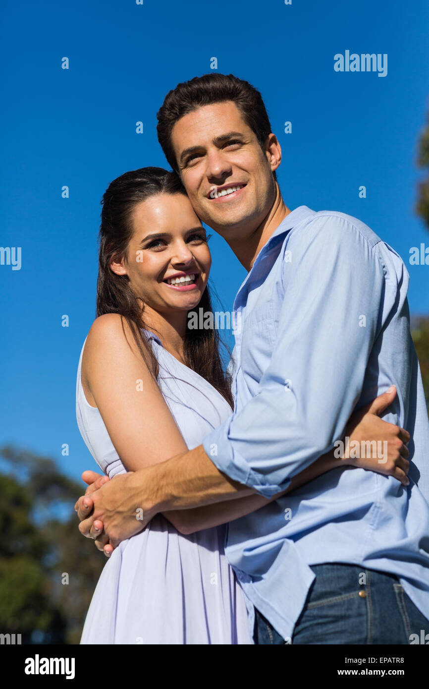 Loving couple embracing each other against clear blue sky Stock Photo ...