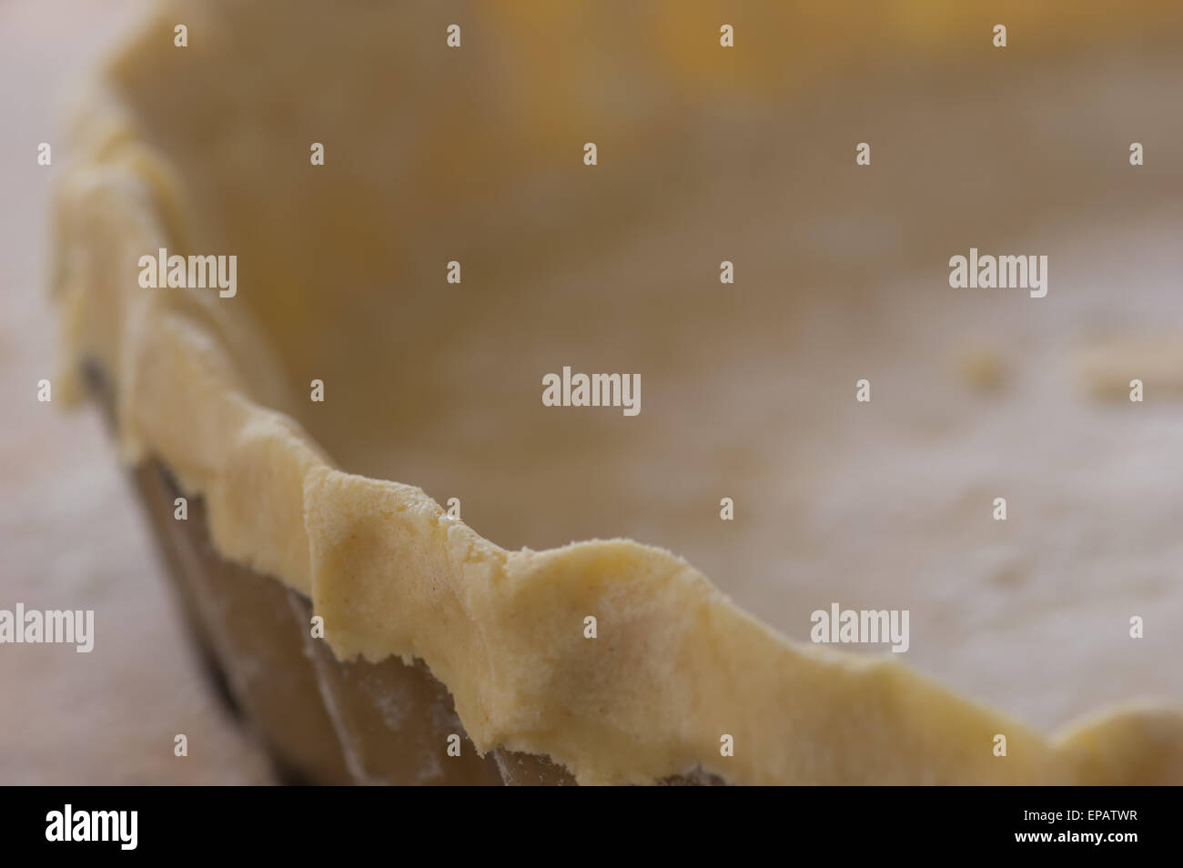 Pastry rolled out and lining a fluted flan dish, ready to cook Stock ...