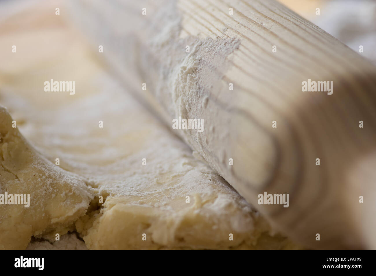 Home made pastry being rolled out with a rolling pin Stock Photo - Alamy