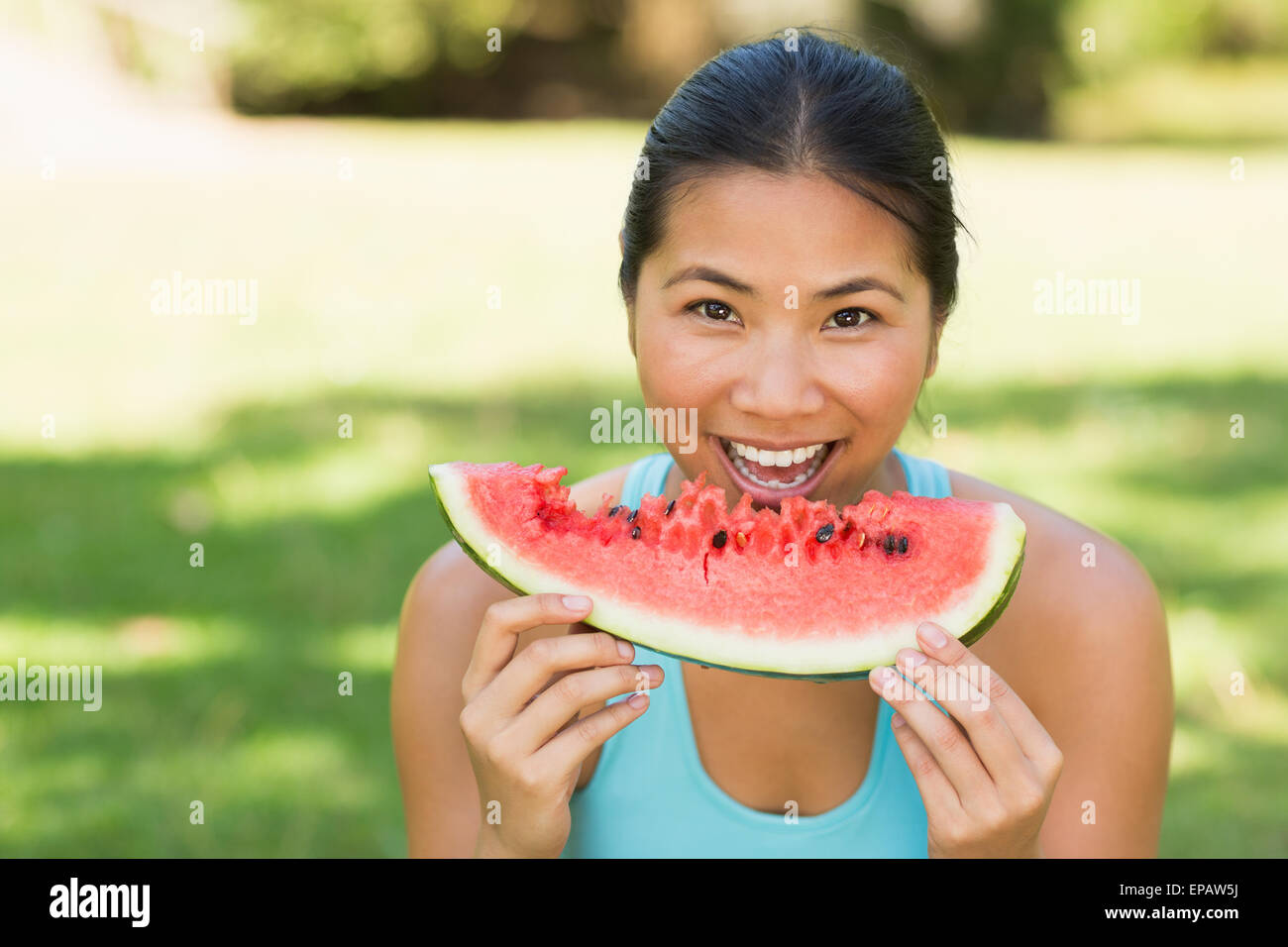 Portrait of a woman eating watermelon in park Stock Photo - Alamy