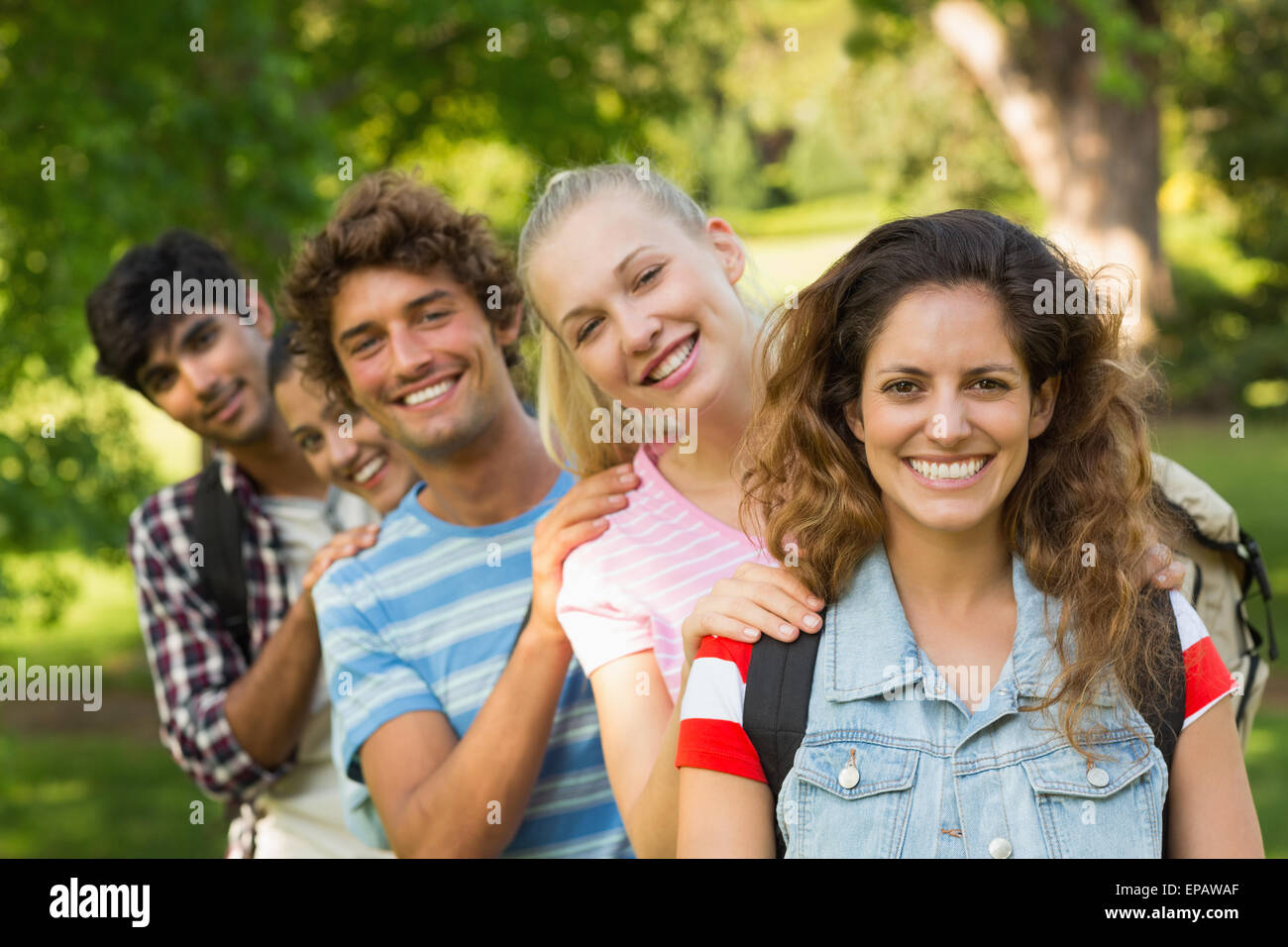 Happy college friends standing in row at campus Stock Photo - Alamy