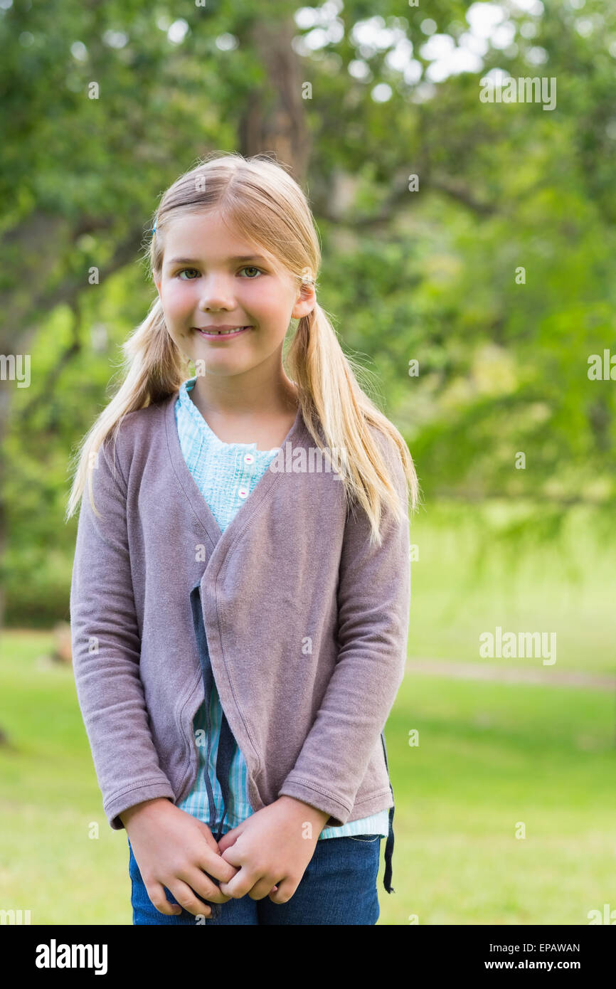Cute smiling girl standing at the park Stock Photo - Alamy