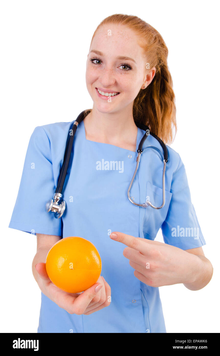 Pretty doctor in blue uniform with stetothcope and orange isolated on ...