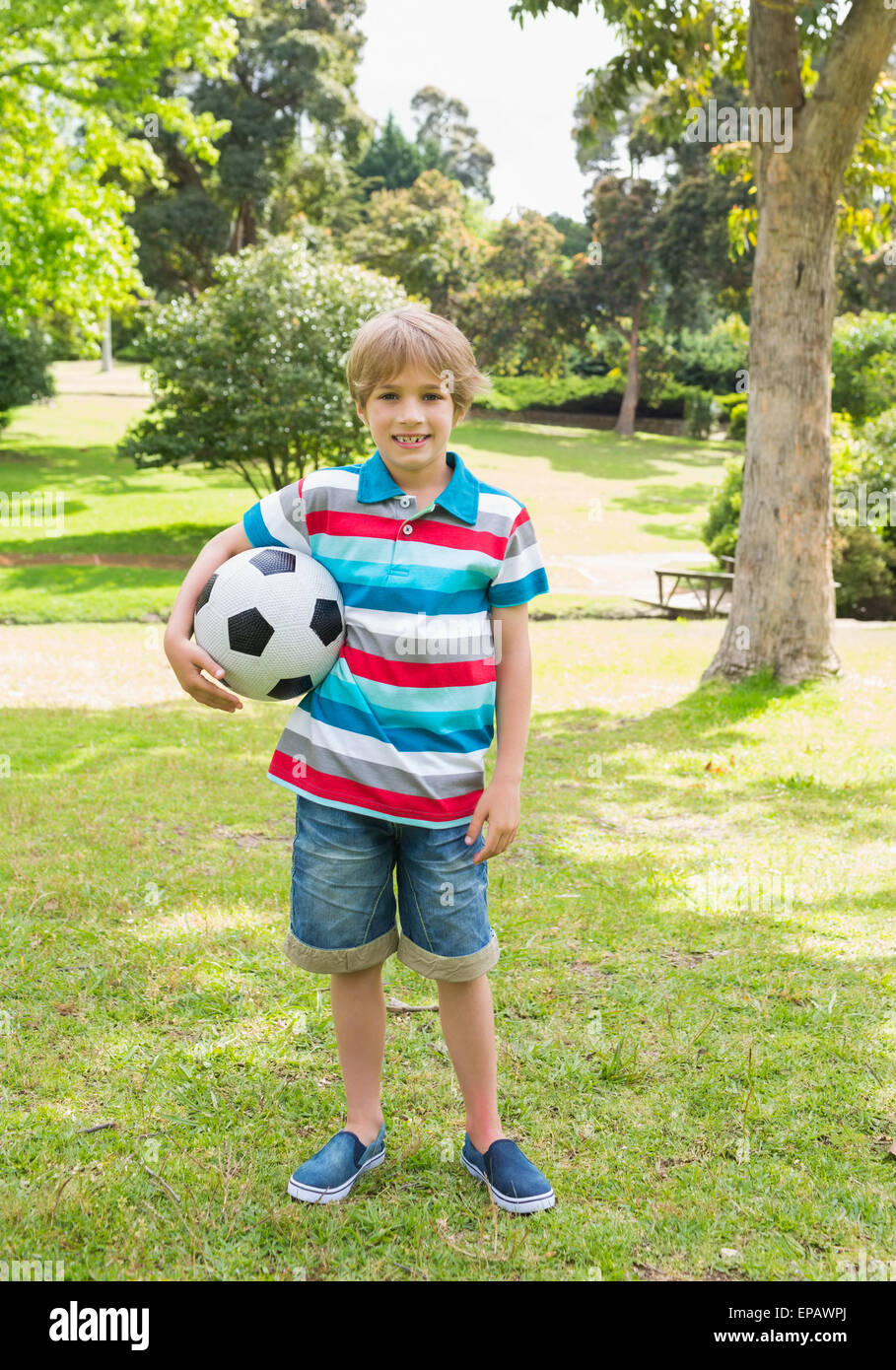 Full length portrait of a boy with ball at park Stock Photo - Alamy