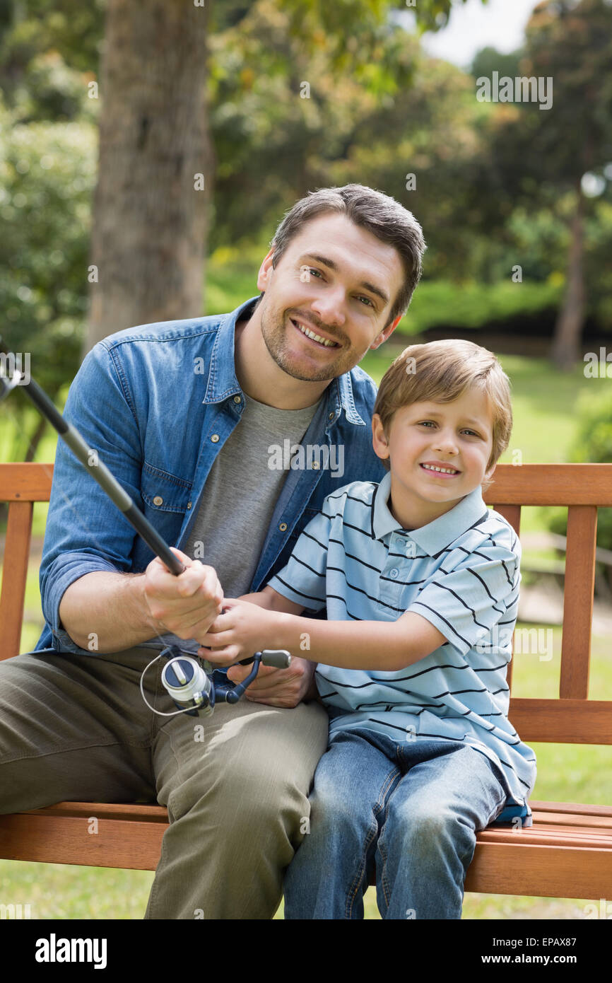 Portrait of a smiling father and son fishing Stock Photo - Alamy