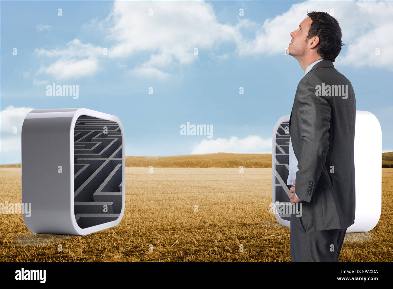 Composite image of smiling businessman with hand on hip Stock Photo - Alamy