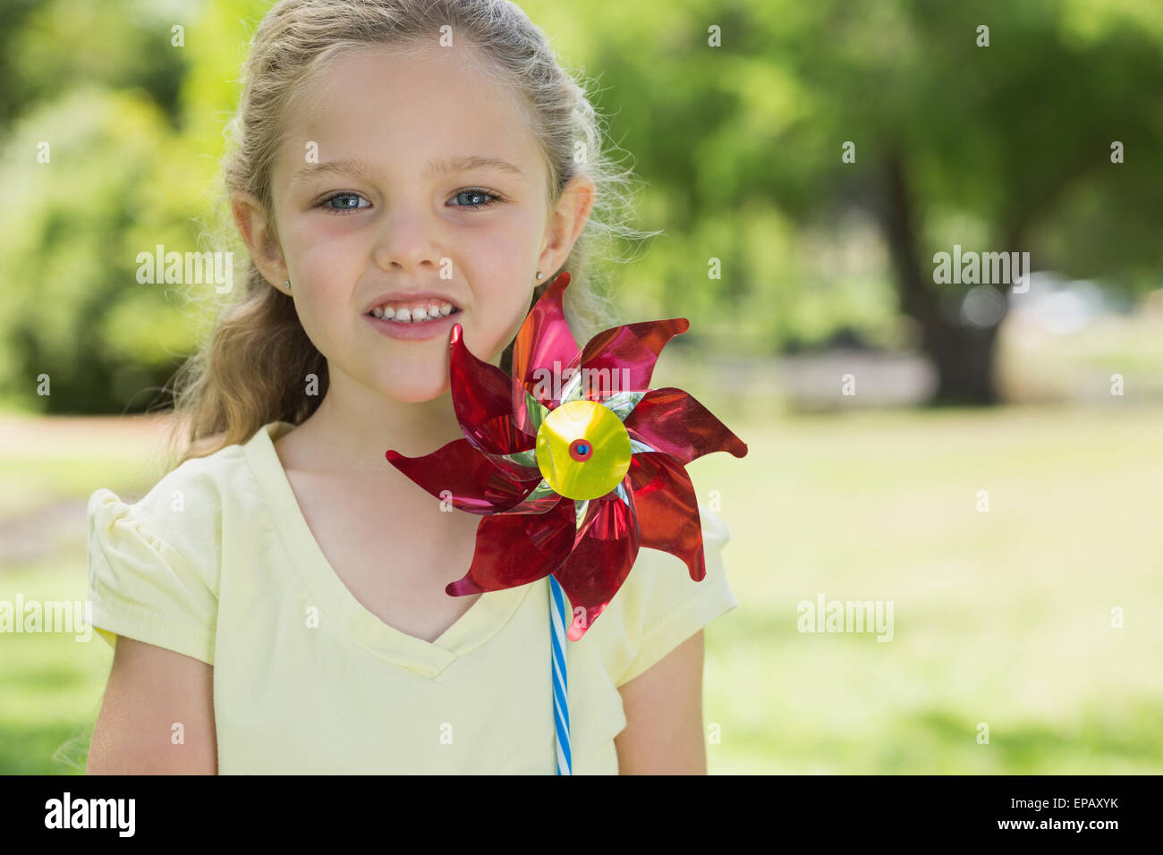 Portrait of cute girl holding pinwheel at park Stock Photo - Alamy