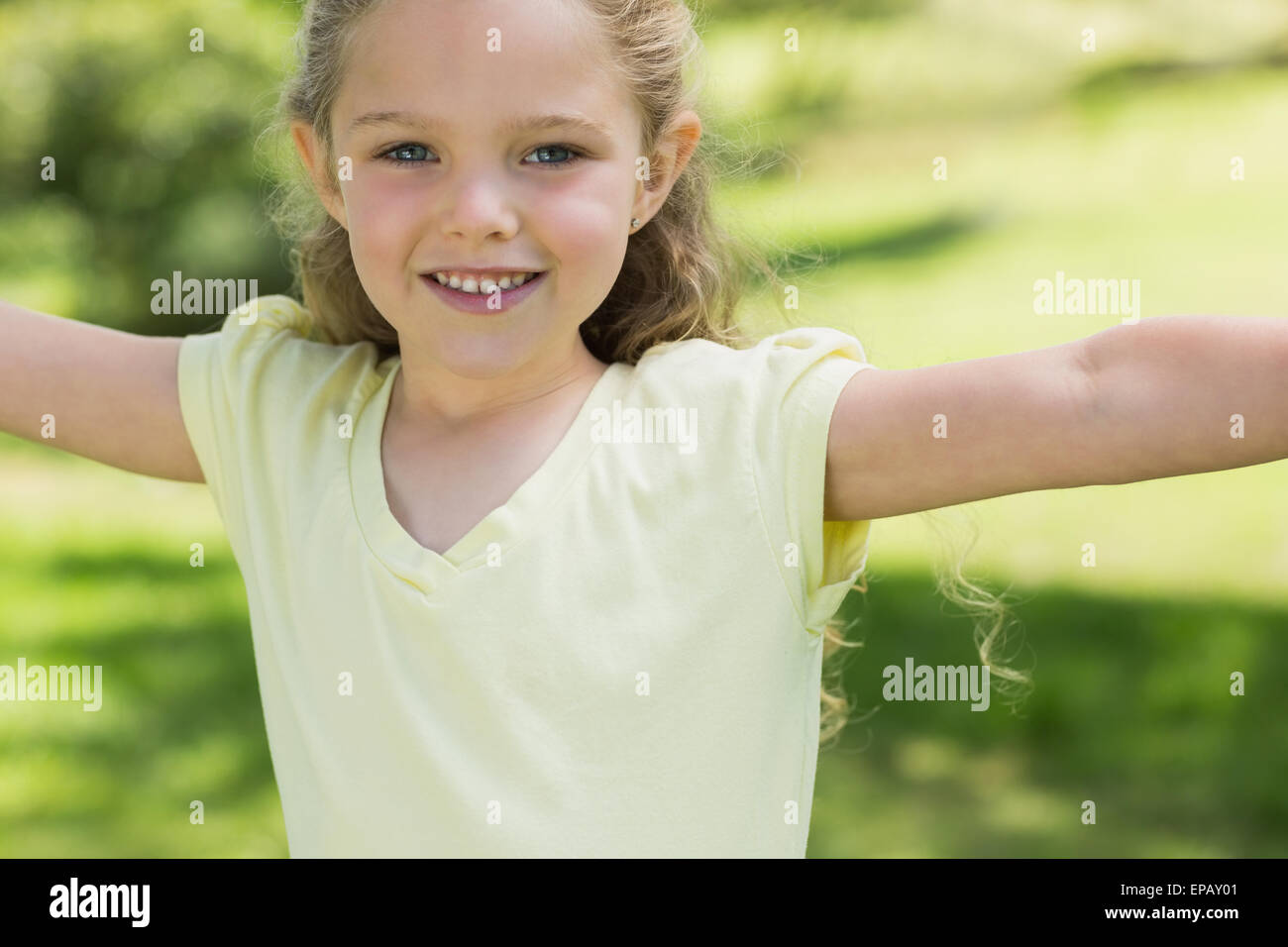 Portrait of a cute smiling girl at park Stock Photo - Alamy