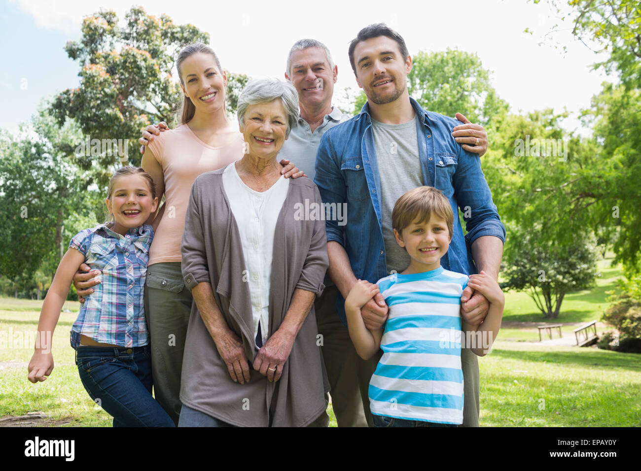 Happy extended family standing at park Stock Photo - Alamy