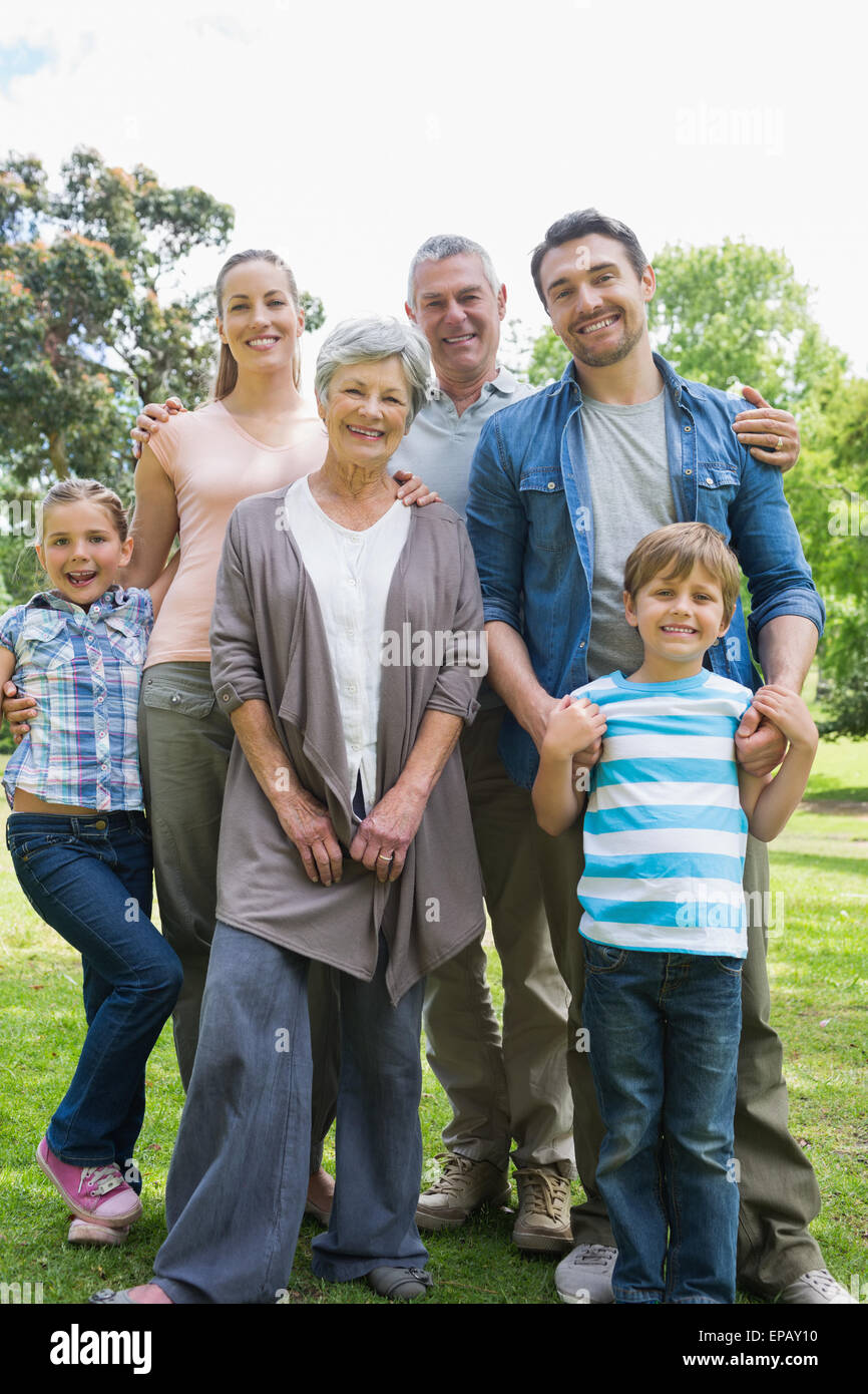 Happy extended family standing at park Stock Photo - Alamy