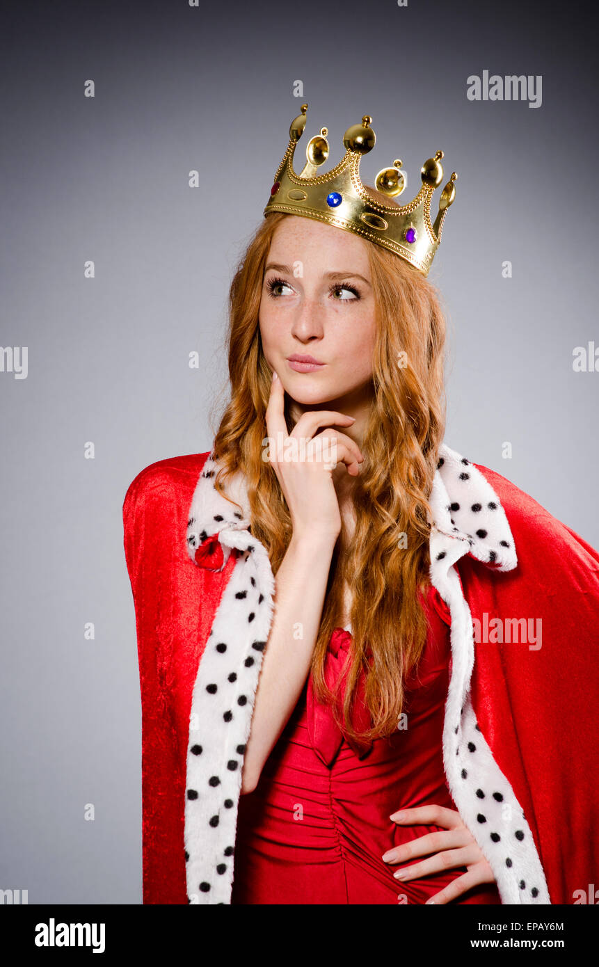 Queen in red dress in studio Stock Photo - Alamy