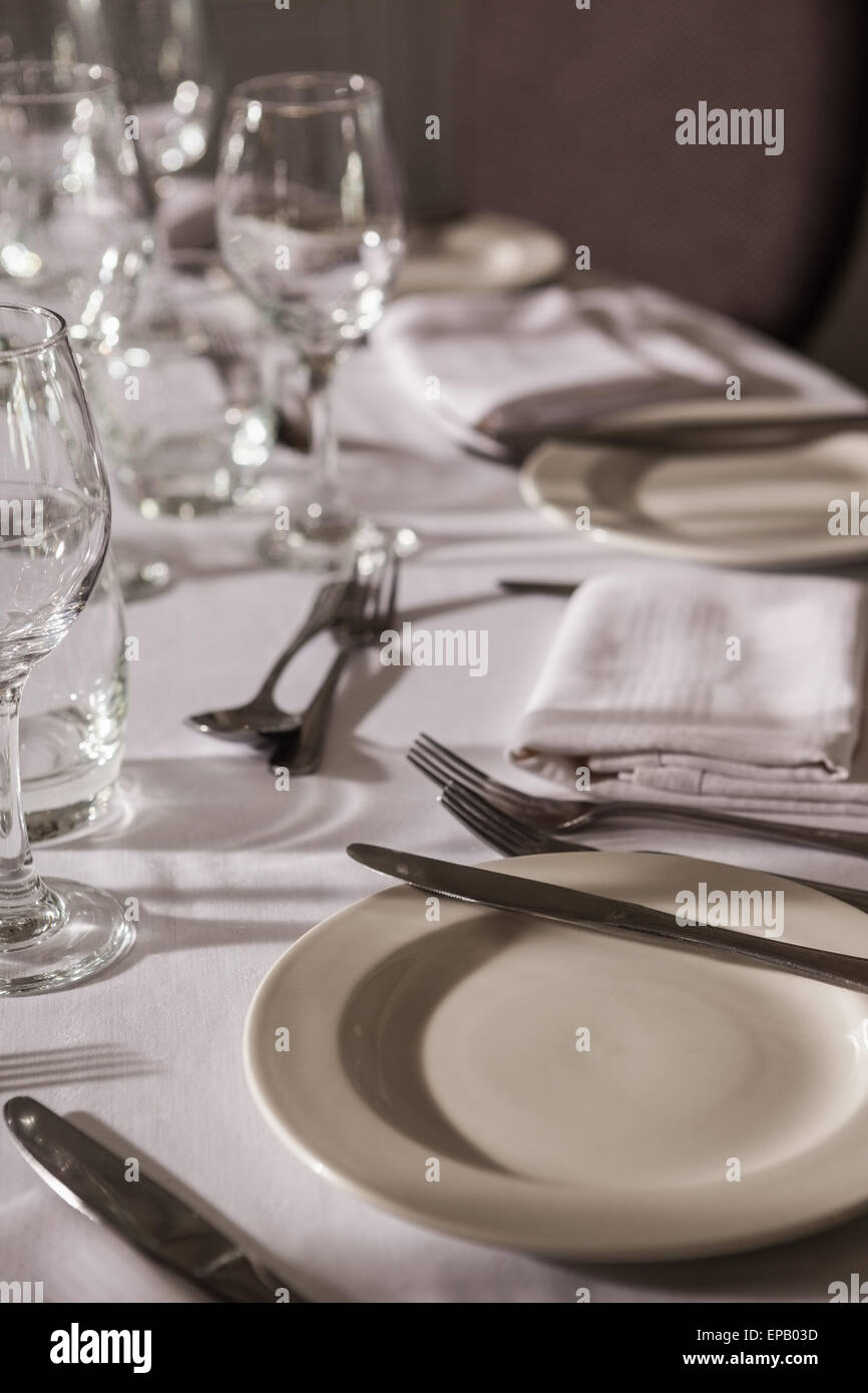 Table set for dinner service with white linen Stock Photo - Alamy
