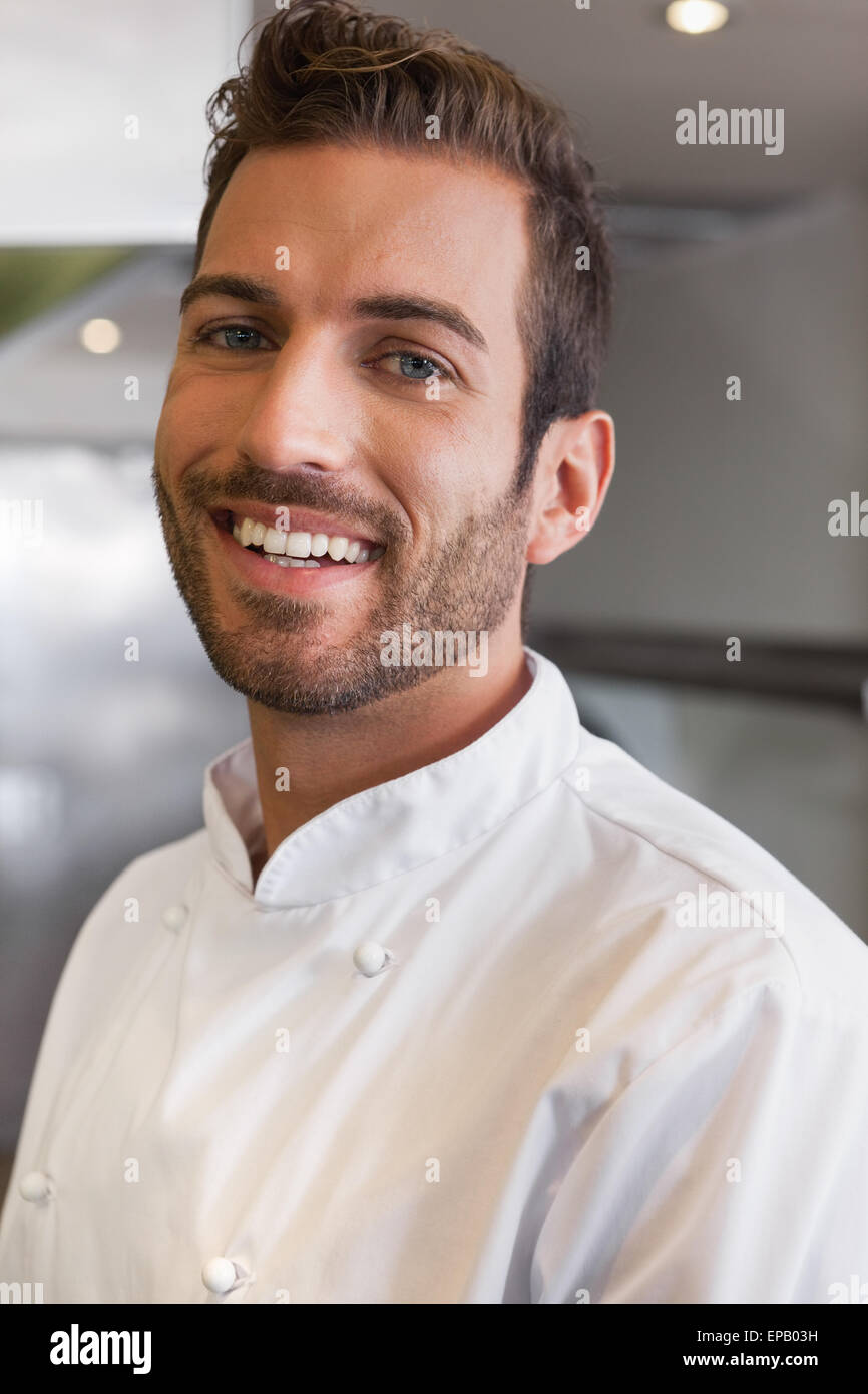 Cheerful handsome young chef looking at camera Stock Photo - Alamy