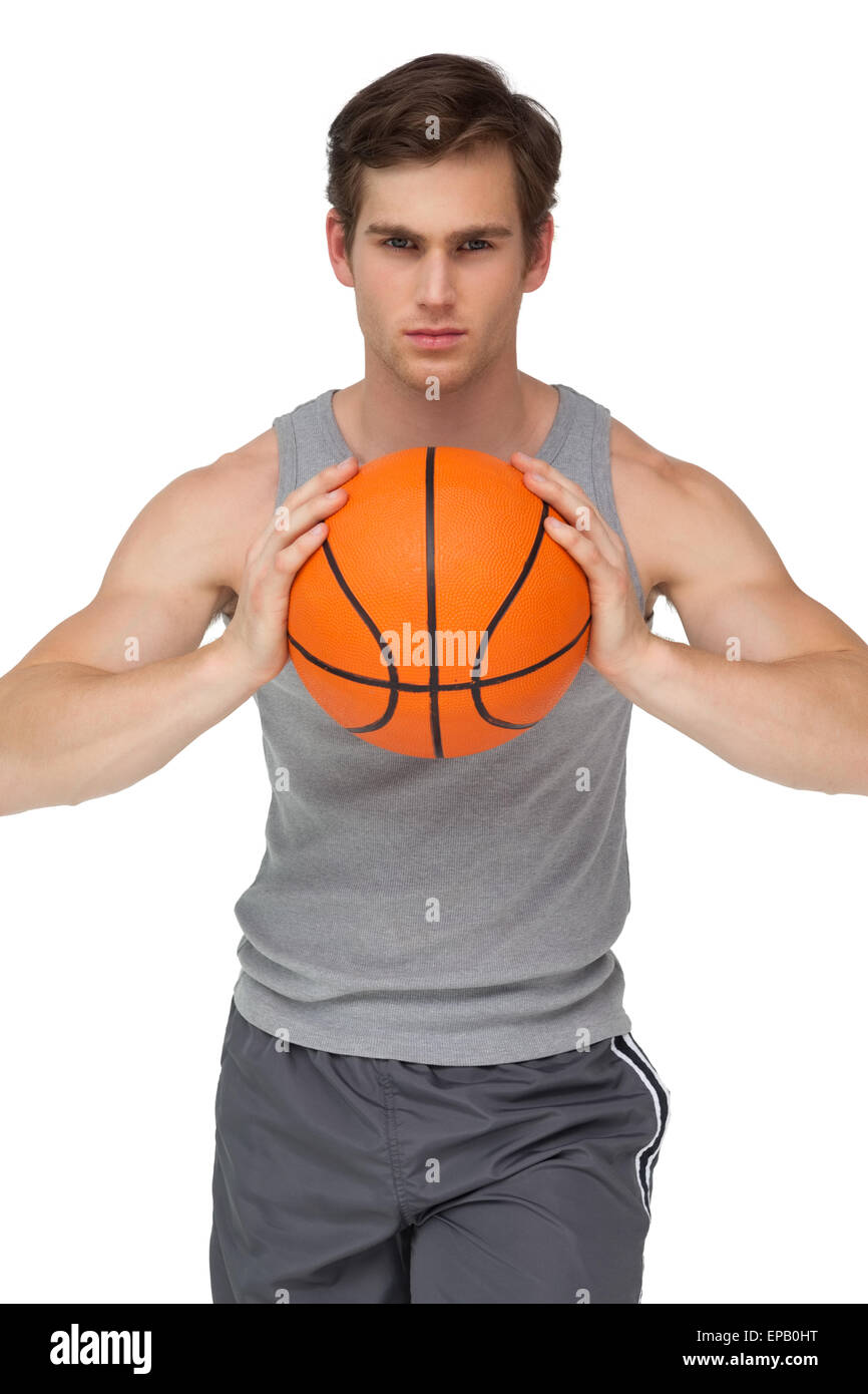Fit man holding basketball about to throw to camera Stock Photo - Alamy