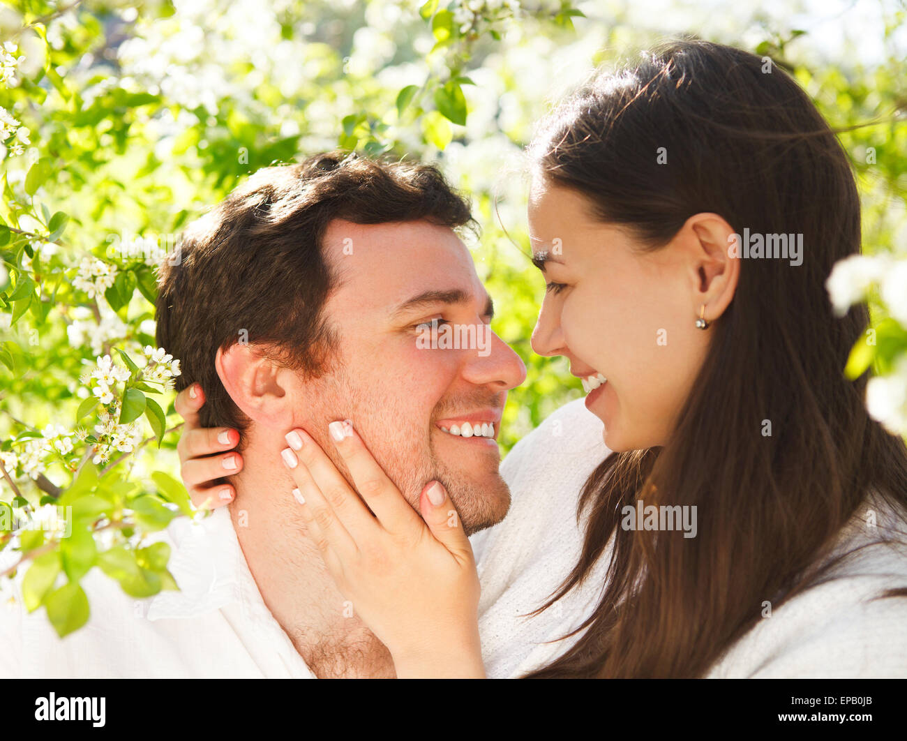 Young happy couple in love in the flowering spring park Stock Photo - Alamy