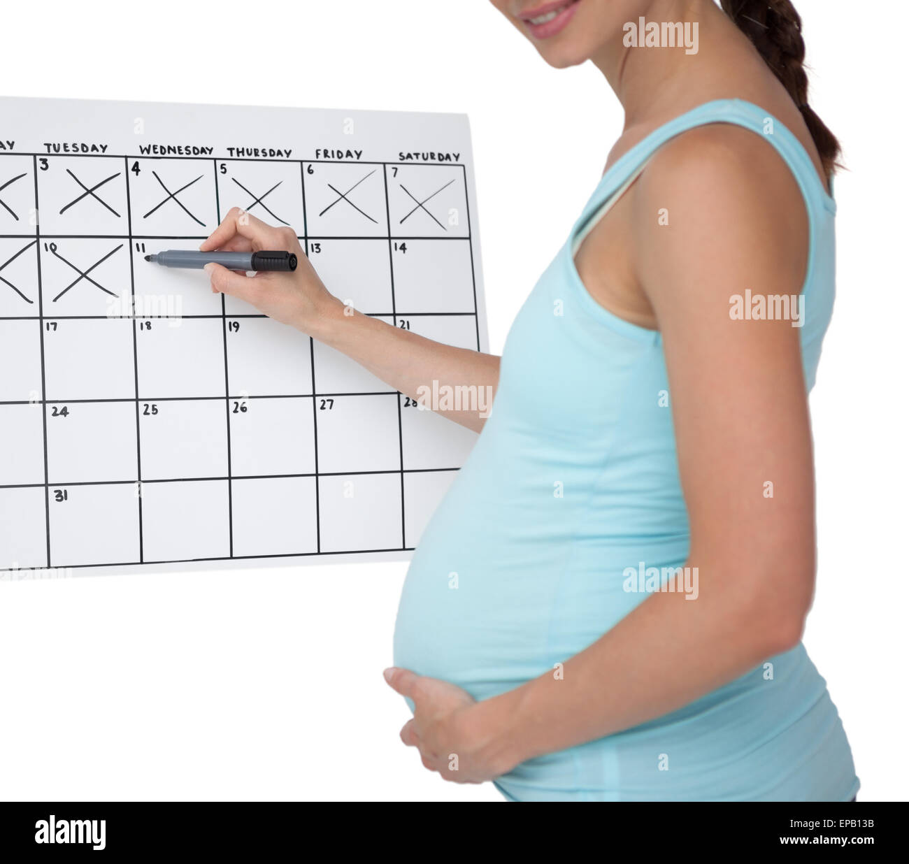 Pregnant woman marking off dates on the calendar on white background ...