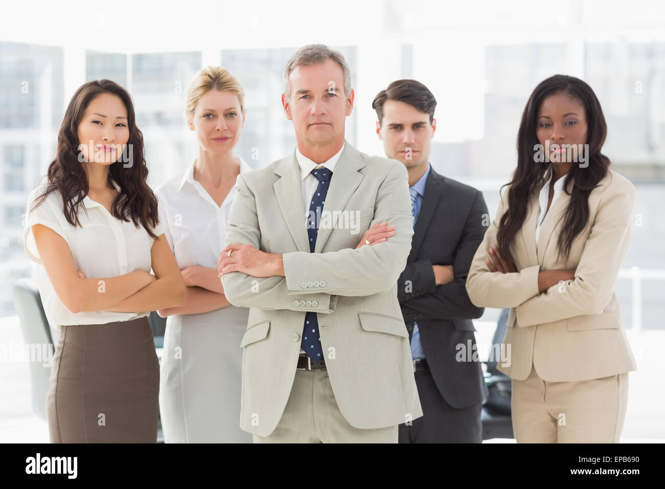 Business team looking at camera with arms crossed Stock Photo - Alamy