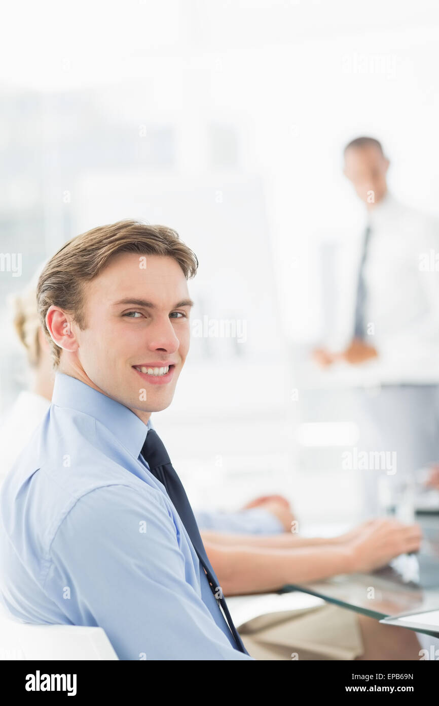 Happy businessman looking at camera during a meeting Stock Photo - Alamy