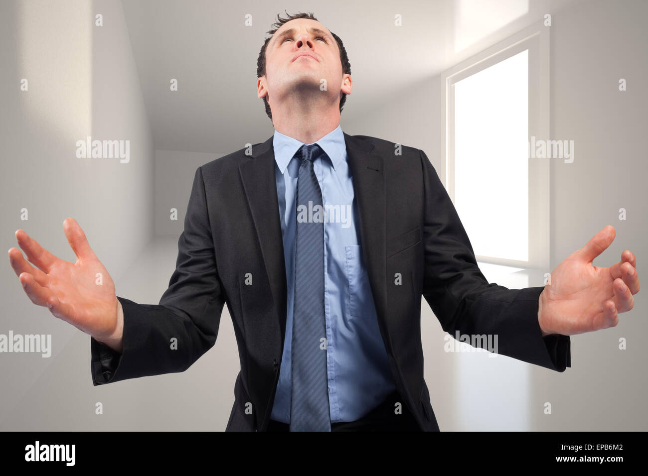 Composite image of businessman posing with arms out Stock Photo - Alamy