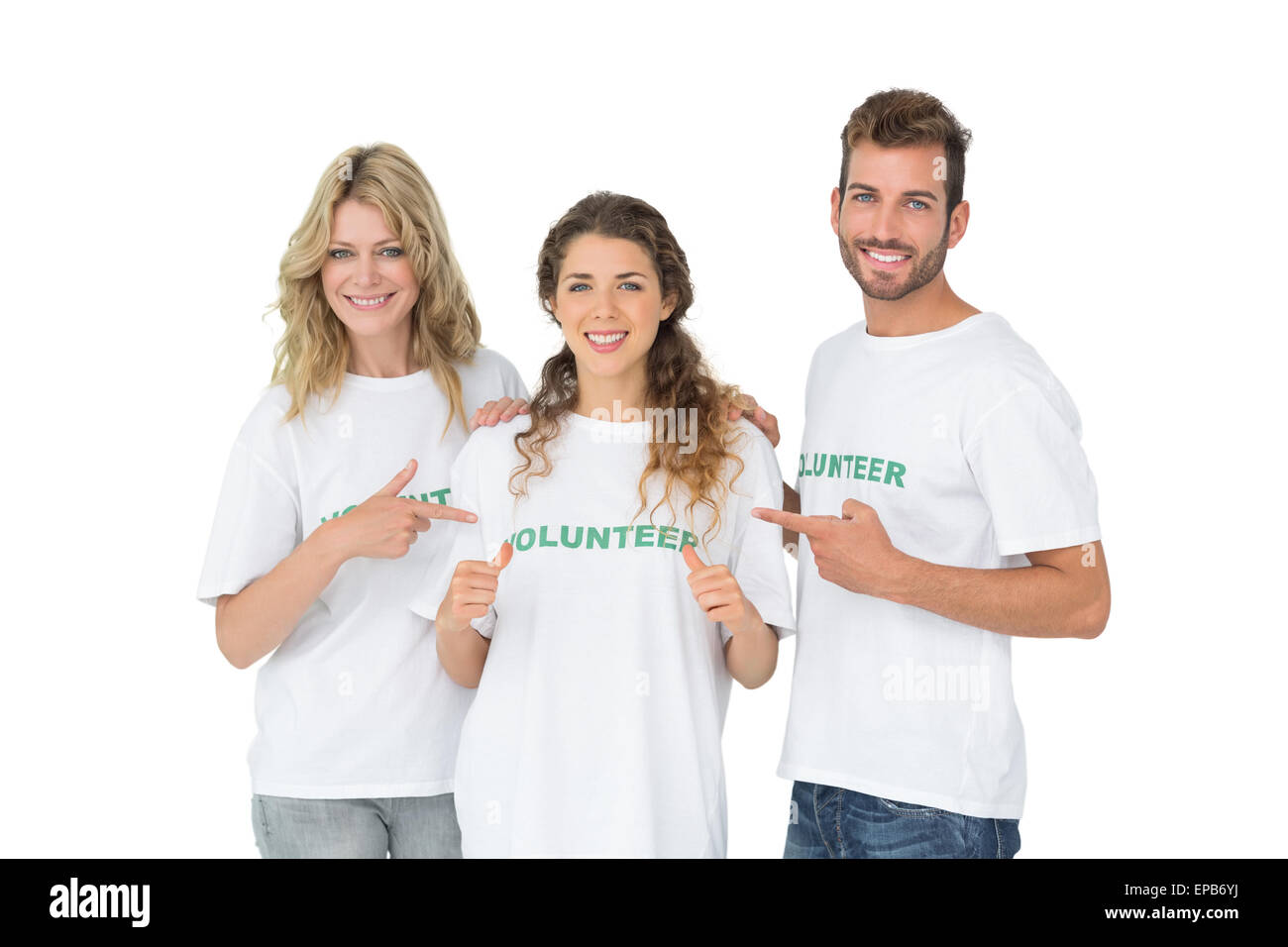 Portrait of happy volunteers pointing to friend Stock Photo - Alamy