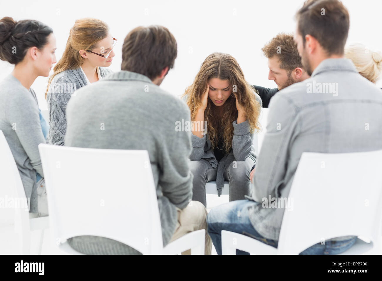 Group therapy in session sitting in a circle Stock Photo - Alamy