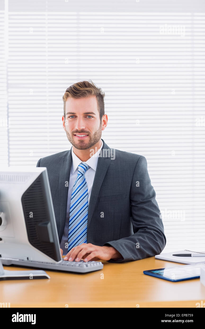 Businessman using computer at office desk Stock Photo - Alamy