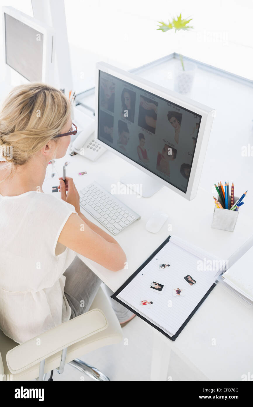 Female photo editor working on computer Stock Photo - Alamy