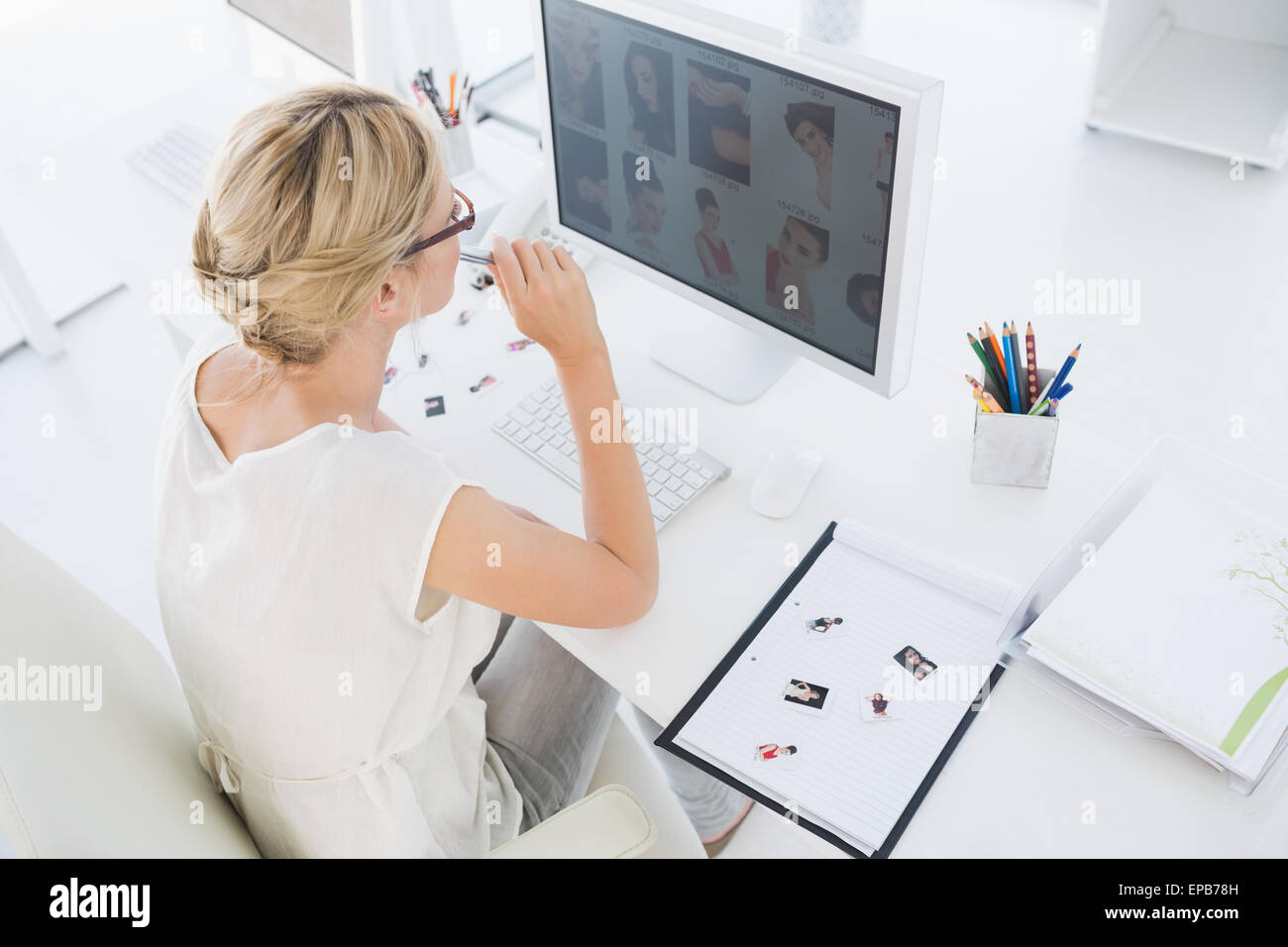 Female photo editor working on computer Stock Photo - Alamy
