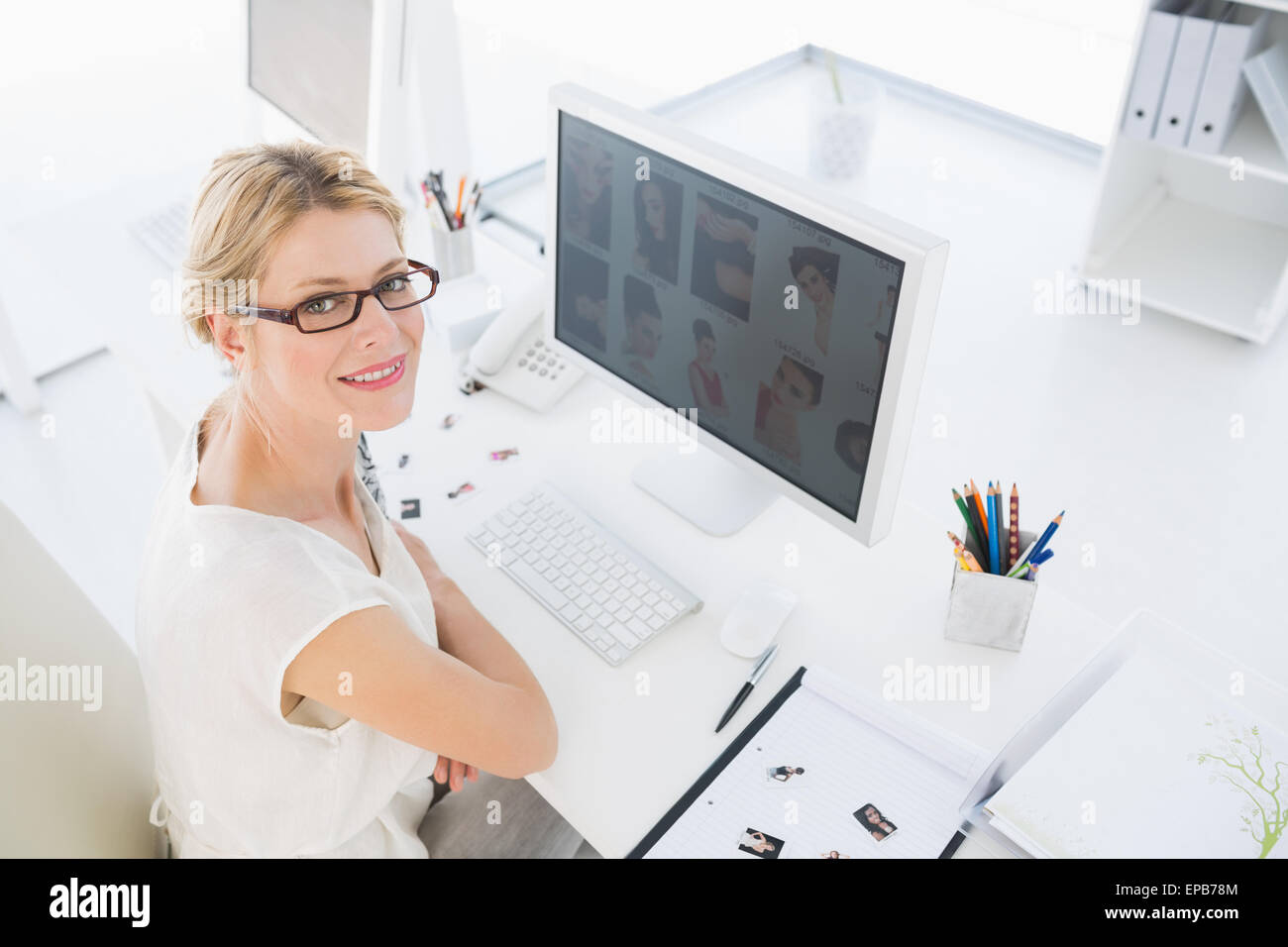 Female photo editor working on computer Stock Photo - Alamy