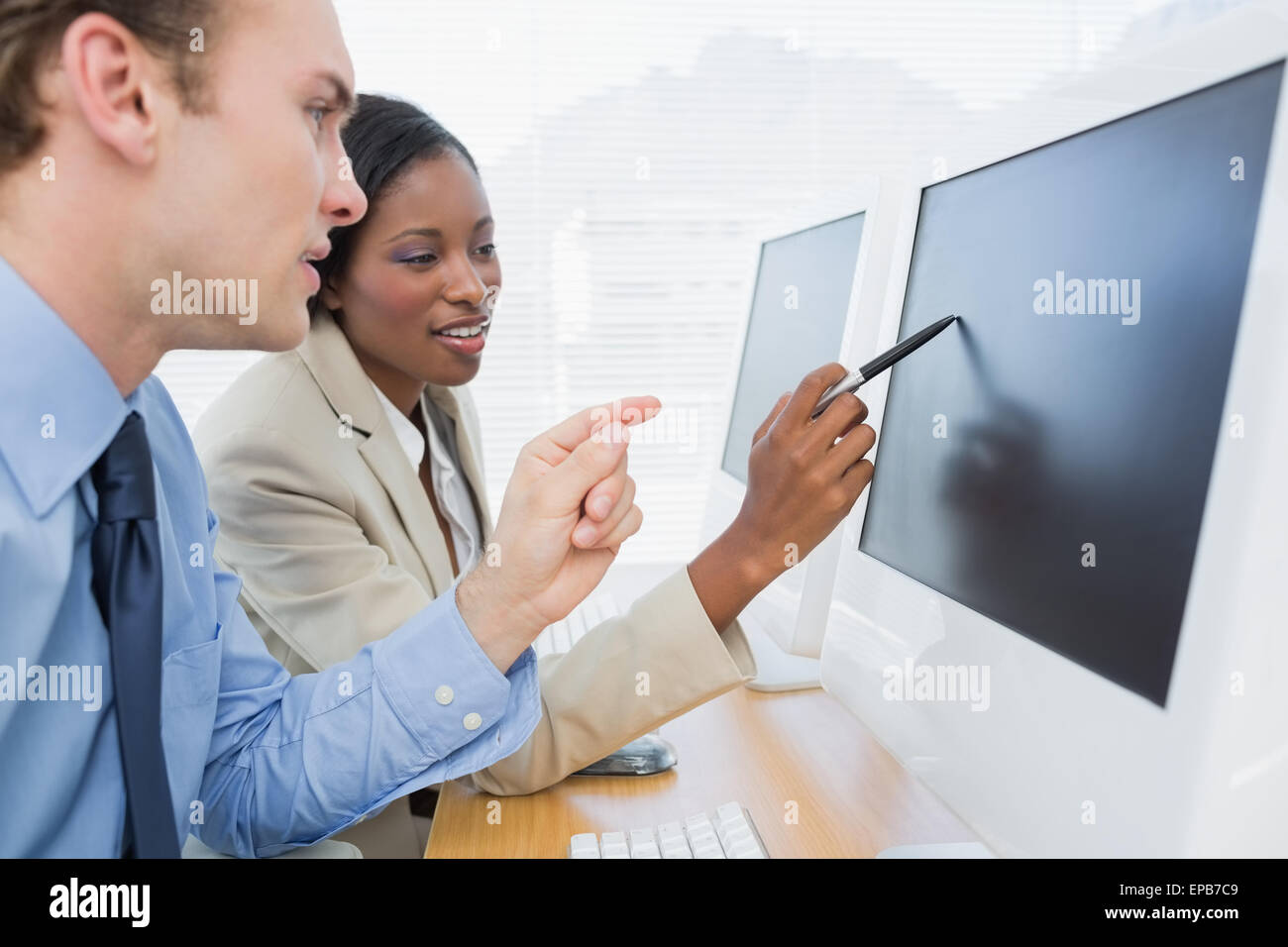 Business colleagues using computers hi-res stock photography and images ...