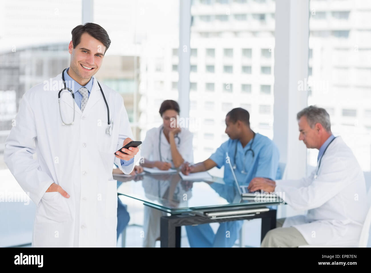 Group standing around desk in hi-res stock photography and images - Alamy