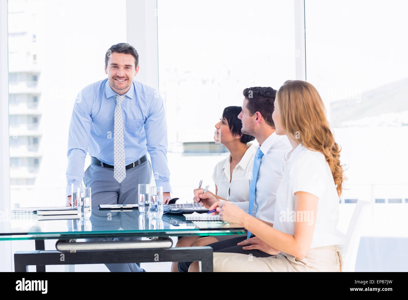 Executives around conference table in office Stock Photo - Alamy
