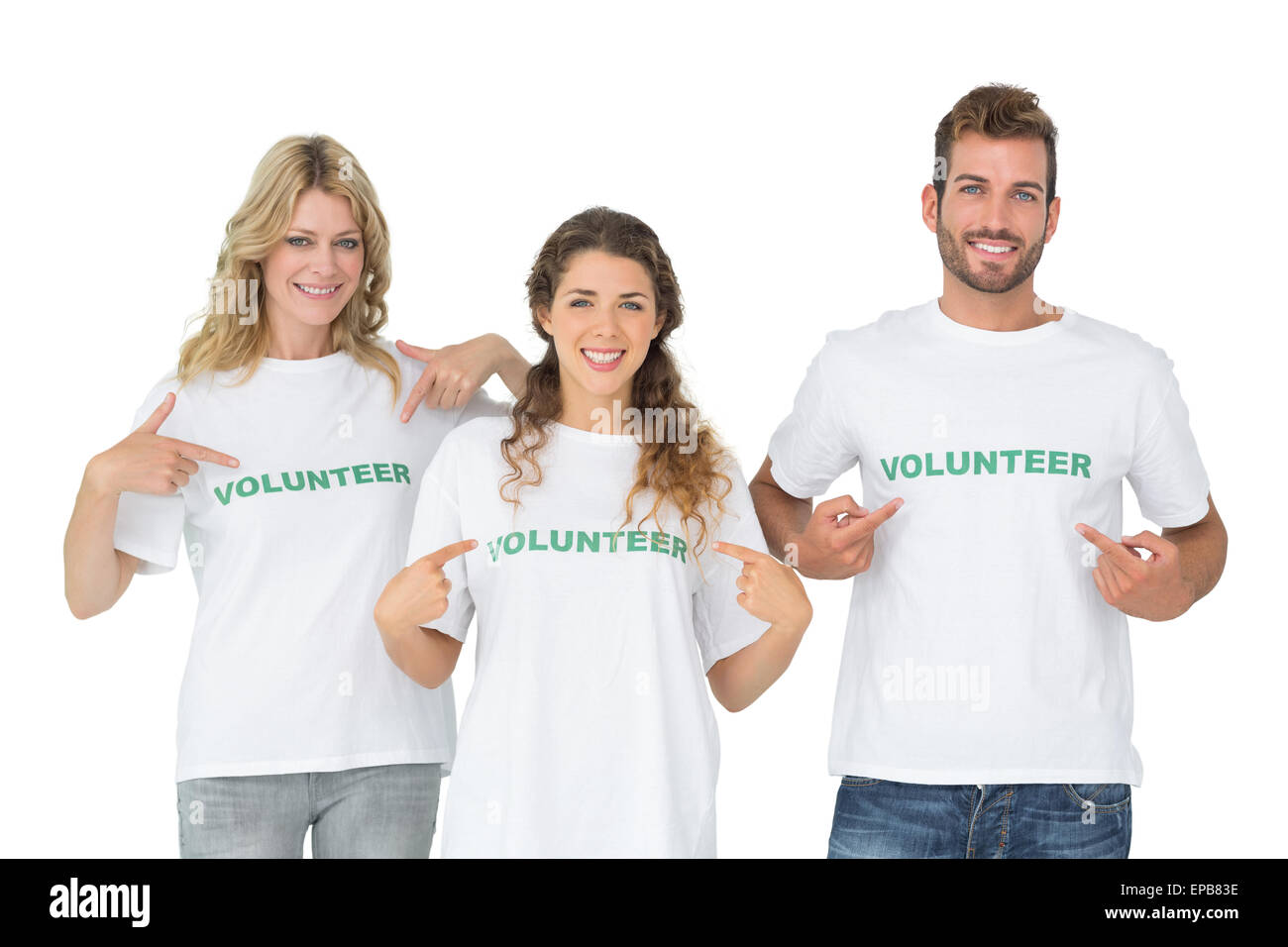 Portrait of three happy volunteers pointing to themselves Stock Photo ...