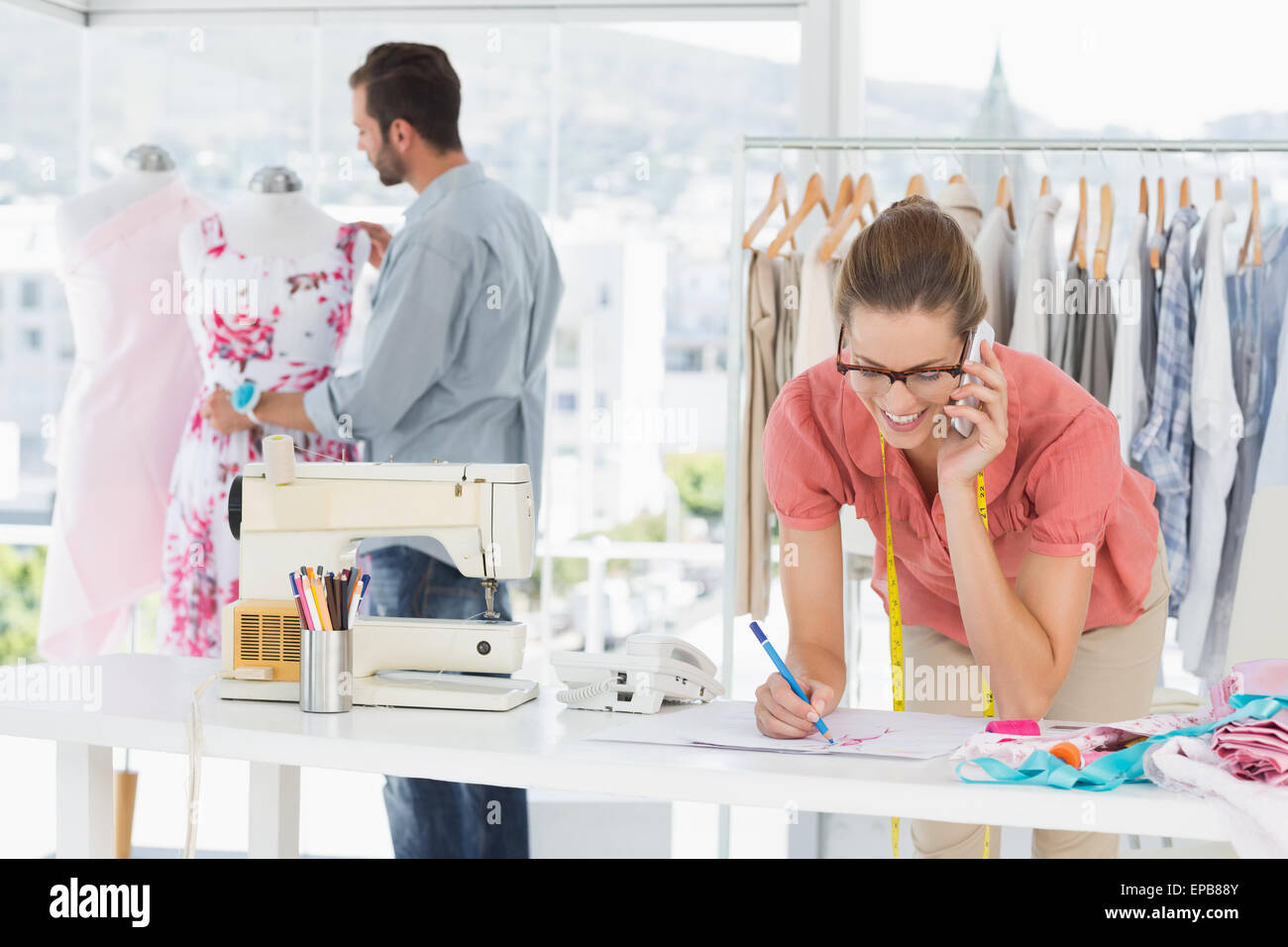 Fashion designers at work in bright studio Stock Photo - Alamy