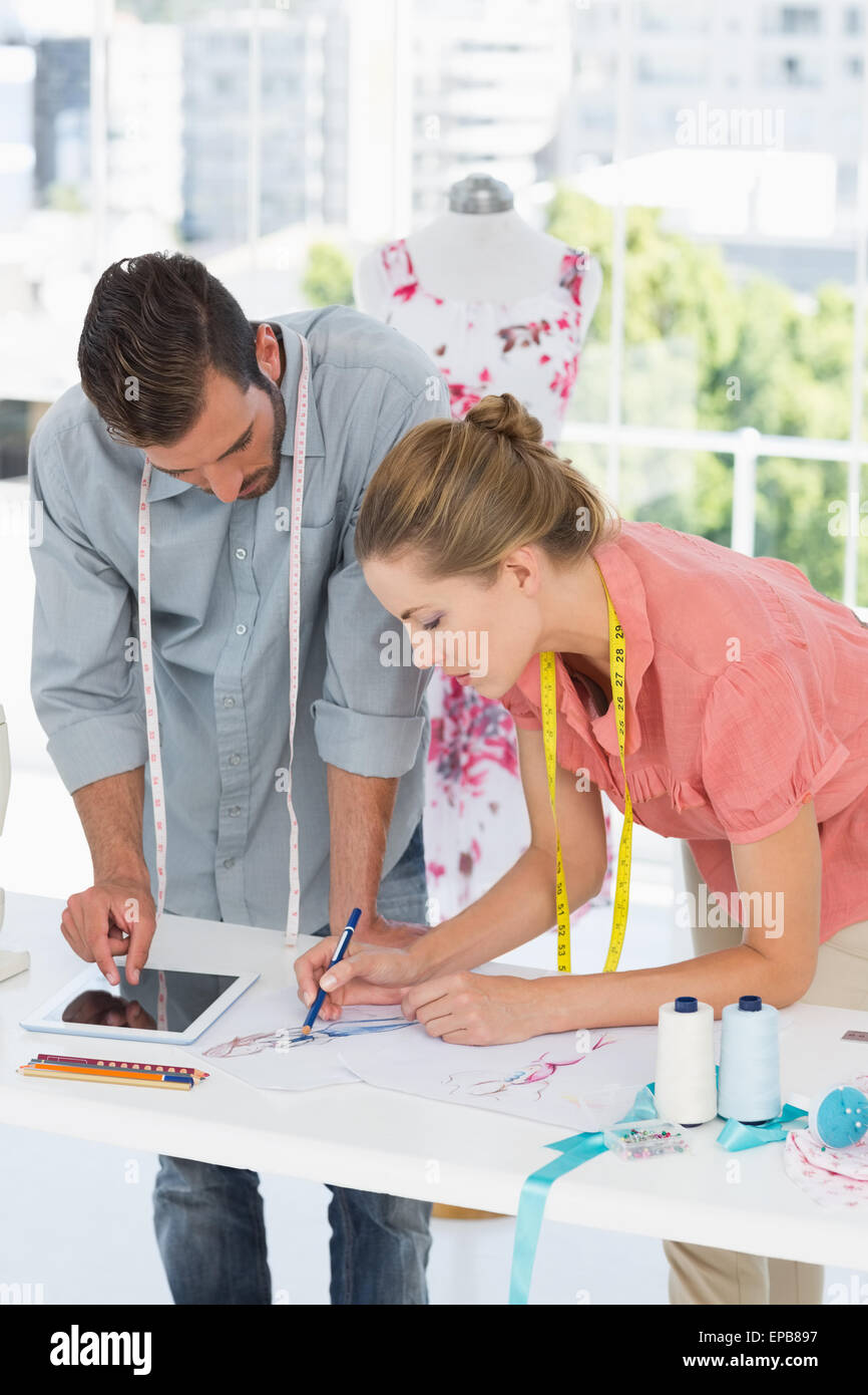 Fashion designers at work in bright studio Stock Photo - Alamy