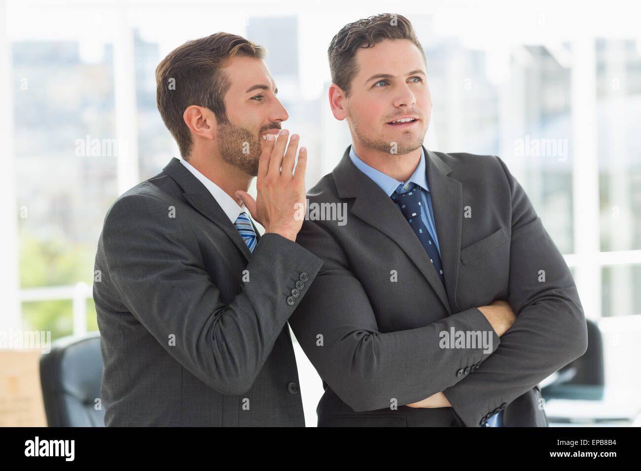 Young well dressed businessmen in discussion Stock Photo - Alamy