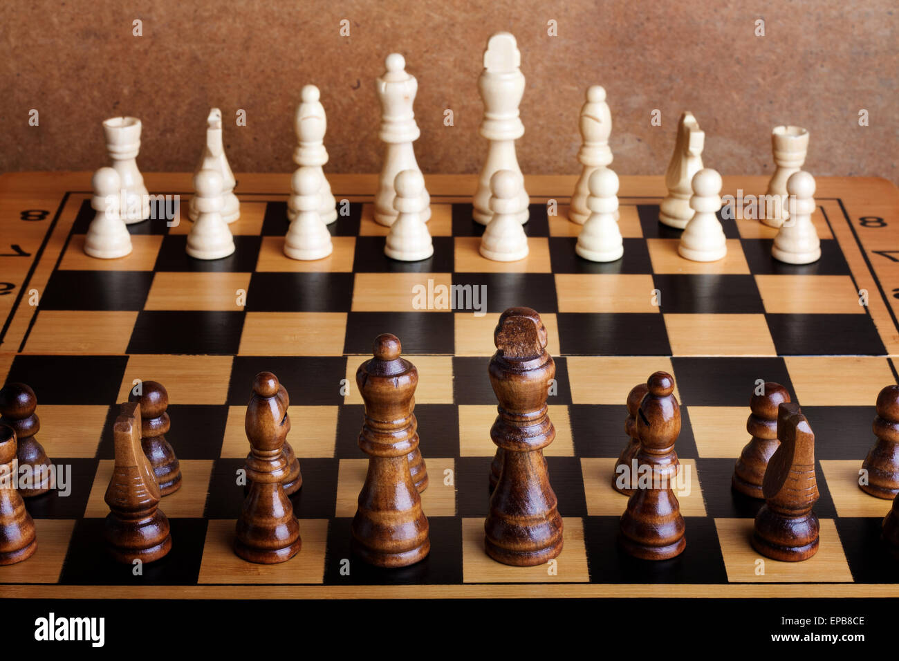 Wooden chess board with figures on table and old wall Stock Photo - Alamy