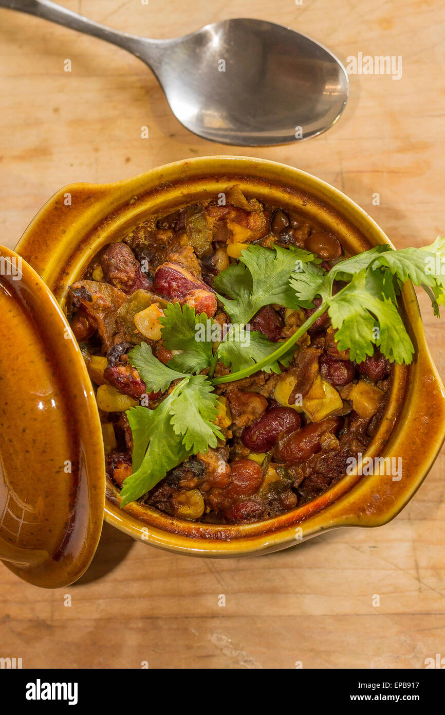 Hot and spicy chili con carne served in a cute mini pot with cilantro ...