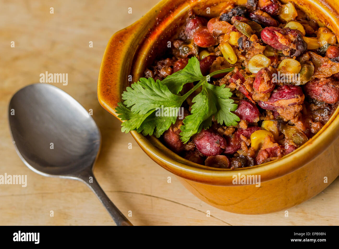 Hot and spicy chili con carne served in a cute mini pot with cilantro ...