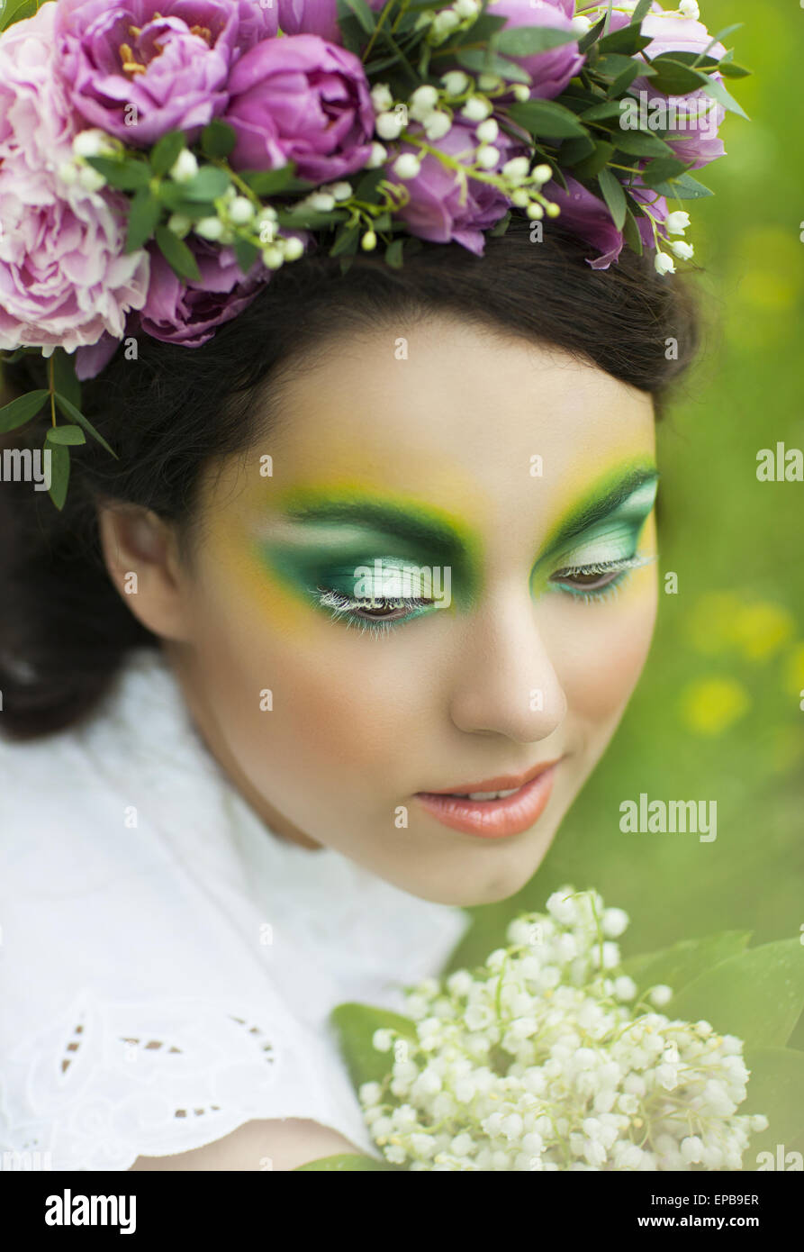 Portrait of a young girl with lily of the valley Stock Photo - Alamy