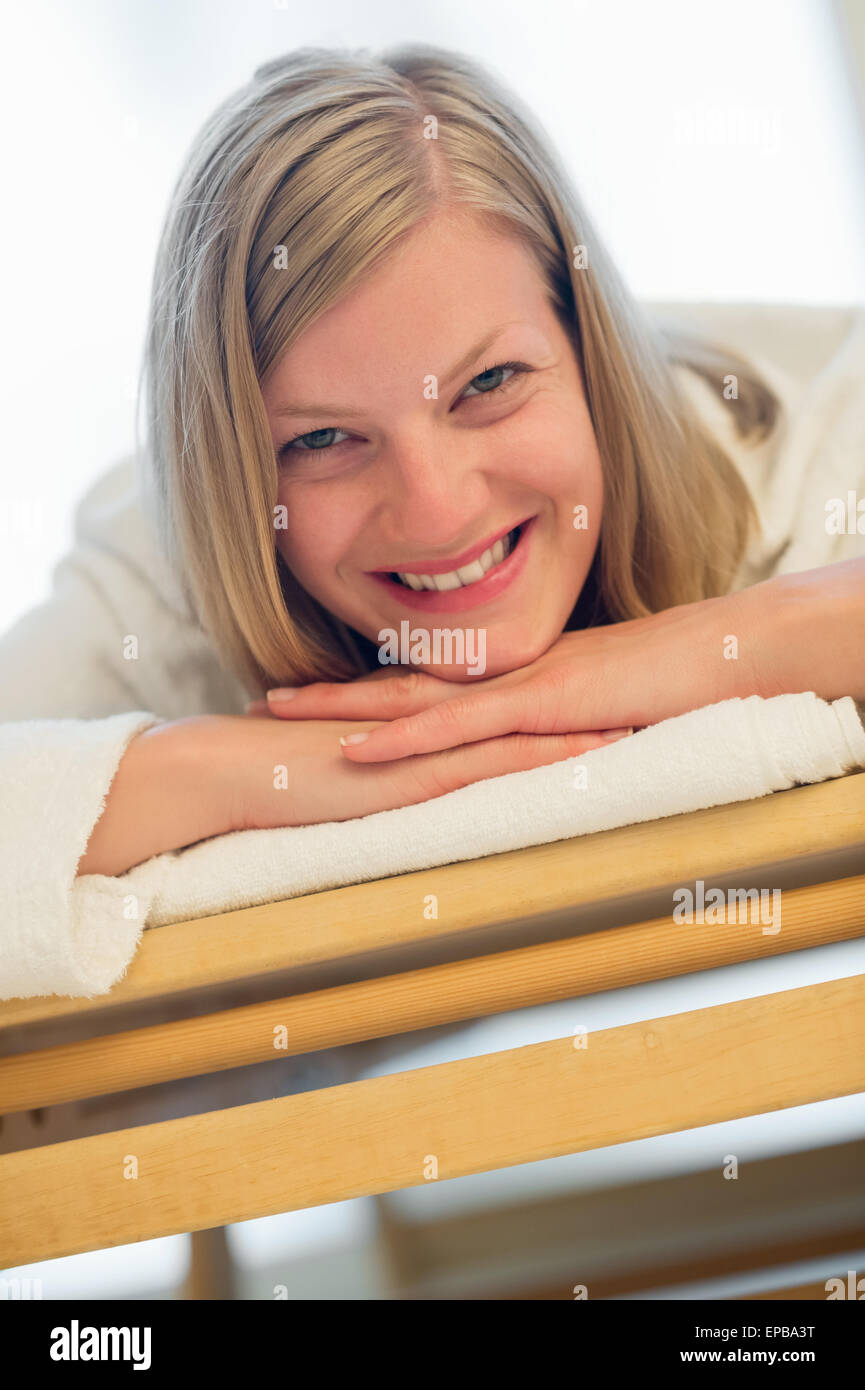 Happy woman lying on bed at spa Stock Photo - Alamy