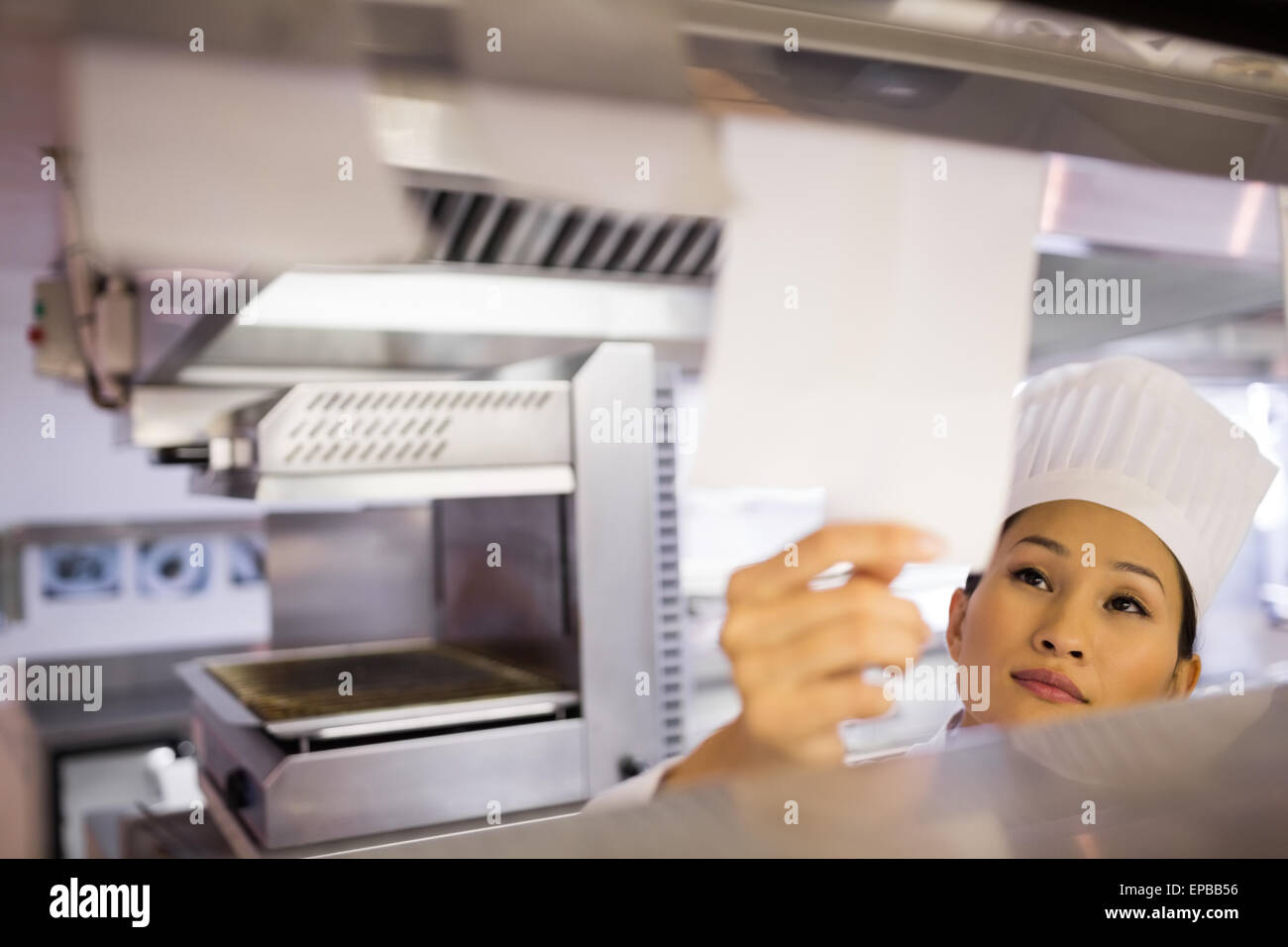 Female chef going through cooking checklist at kitchen Stock Photo - Alamy