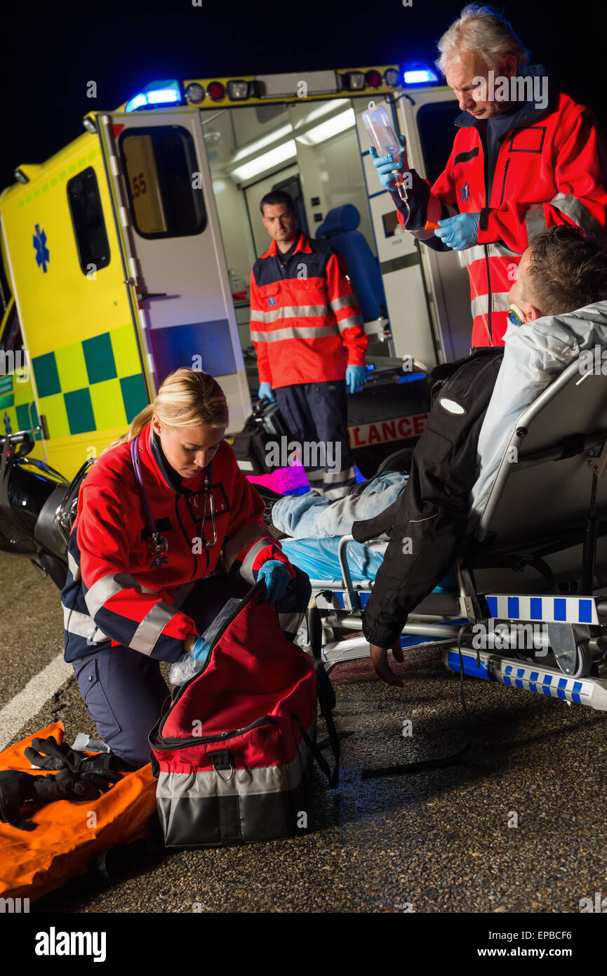 Paramedic team assisting injured motorbike driver Stock Photo - Alamy