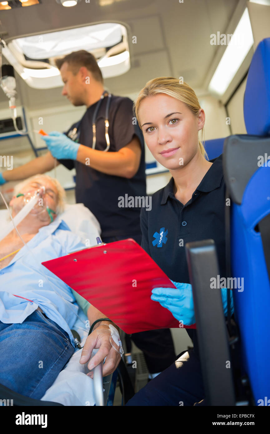Paramedic helping injured patient in ambulance Stock Photo - Alamy